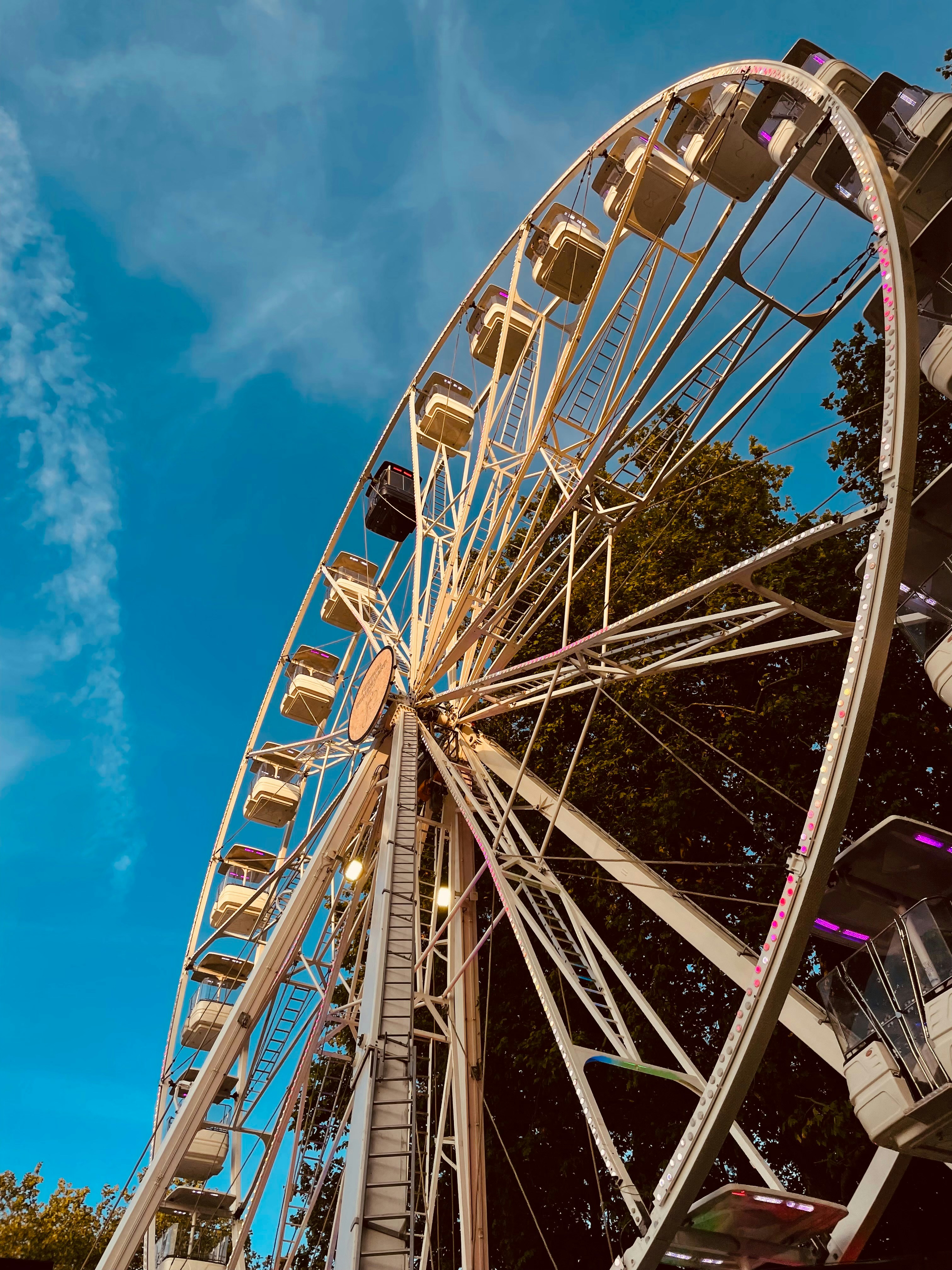 Spinning Sky: A Ferris Wheel Reaches Toward the Blue