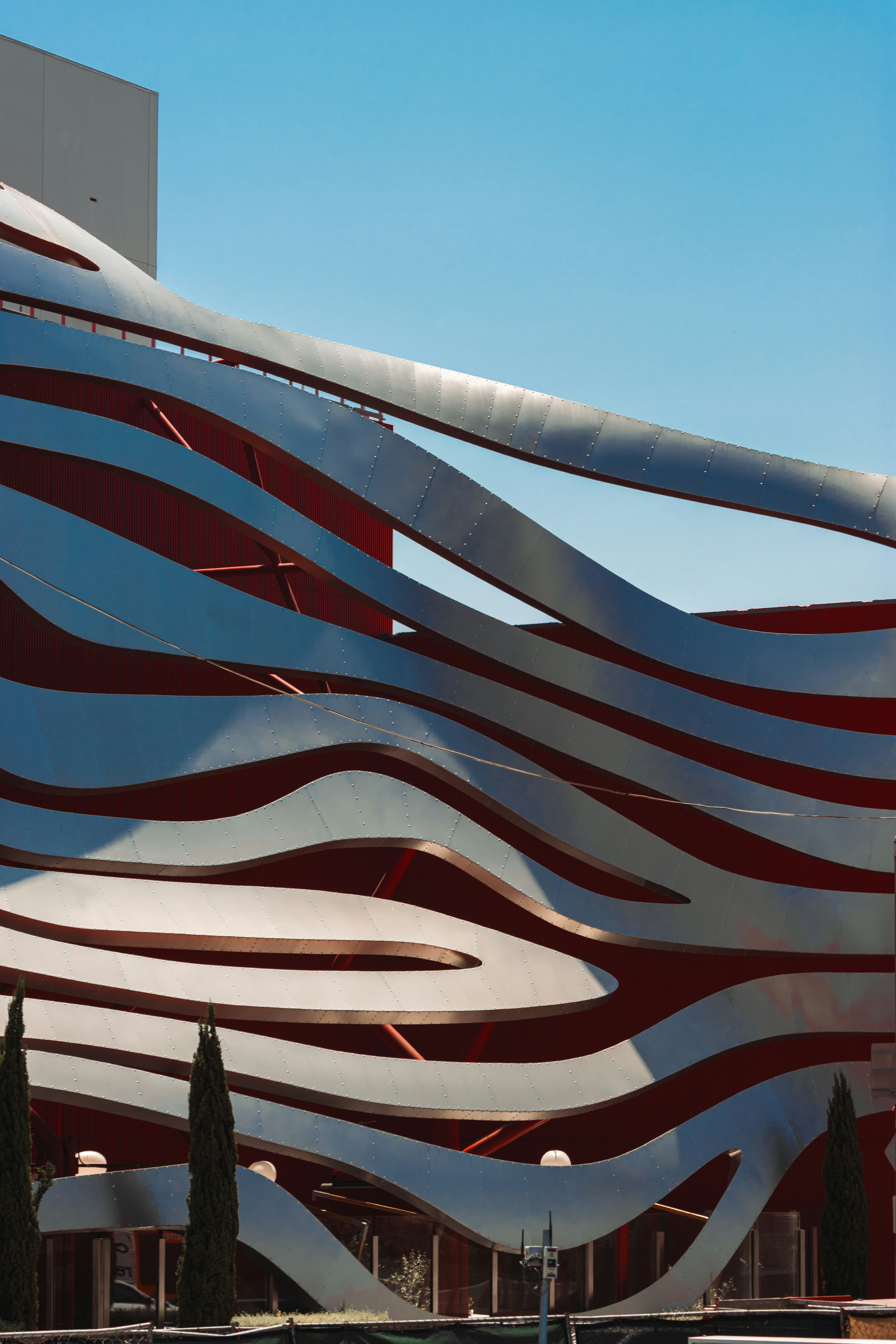 Waves of Chrome: Abstract Facade Singed by Sunlit Stripes