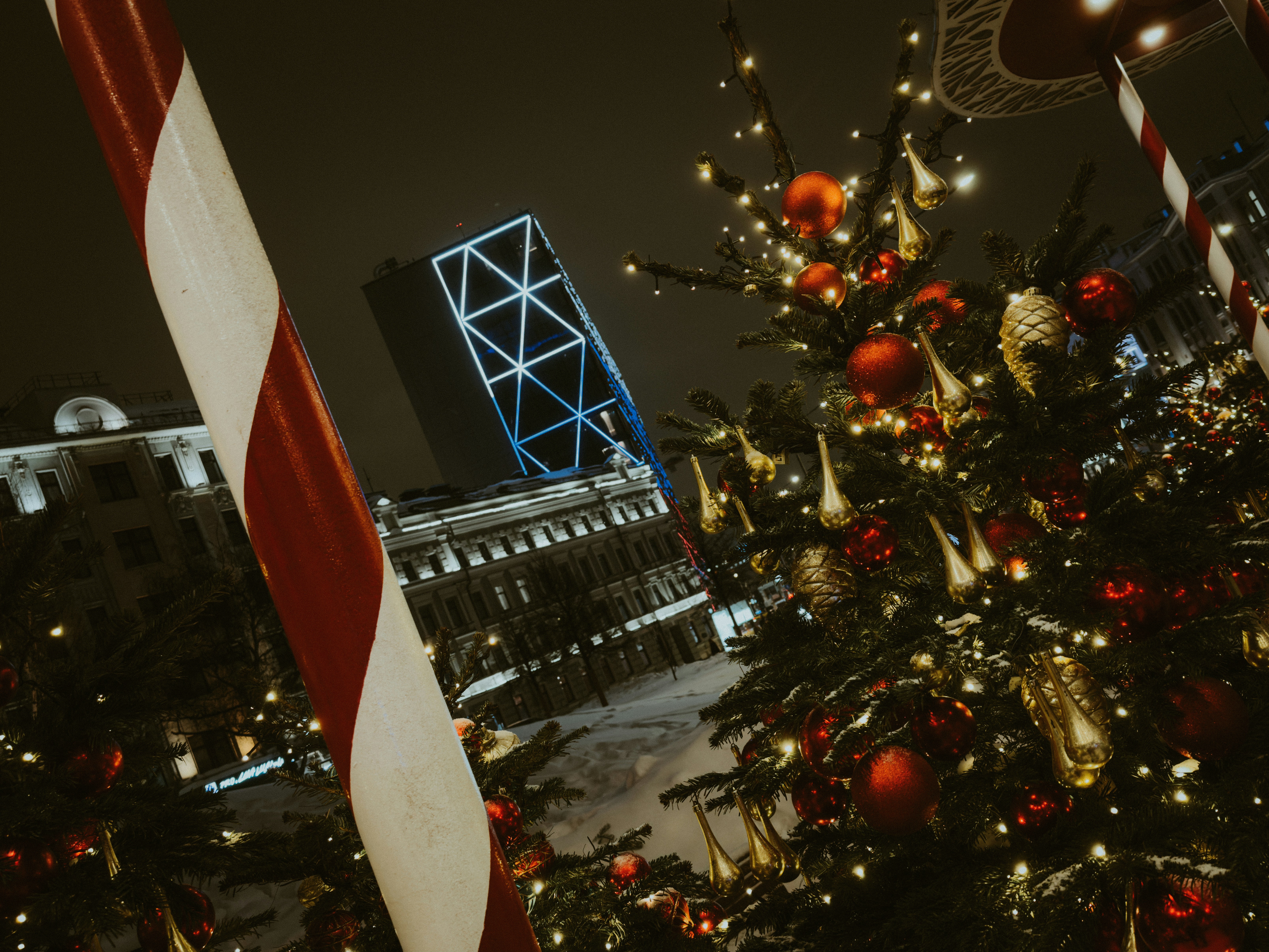 Candy Cane Lights and Holiday Glow over a Snowy Plaza