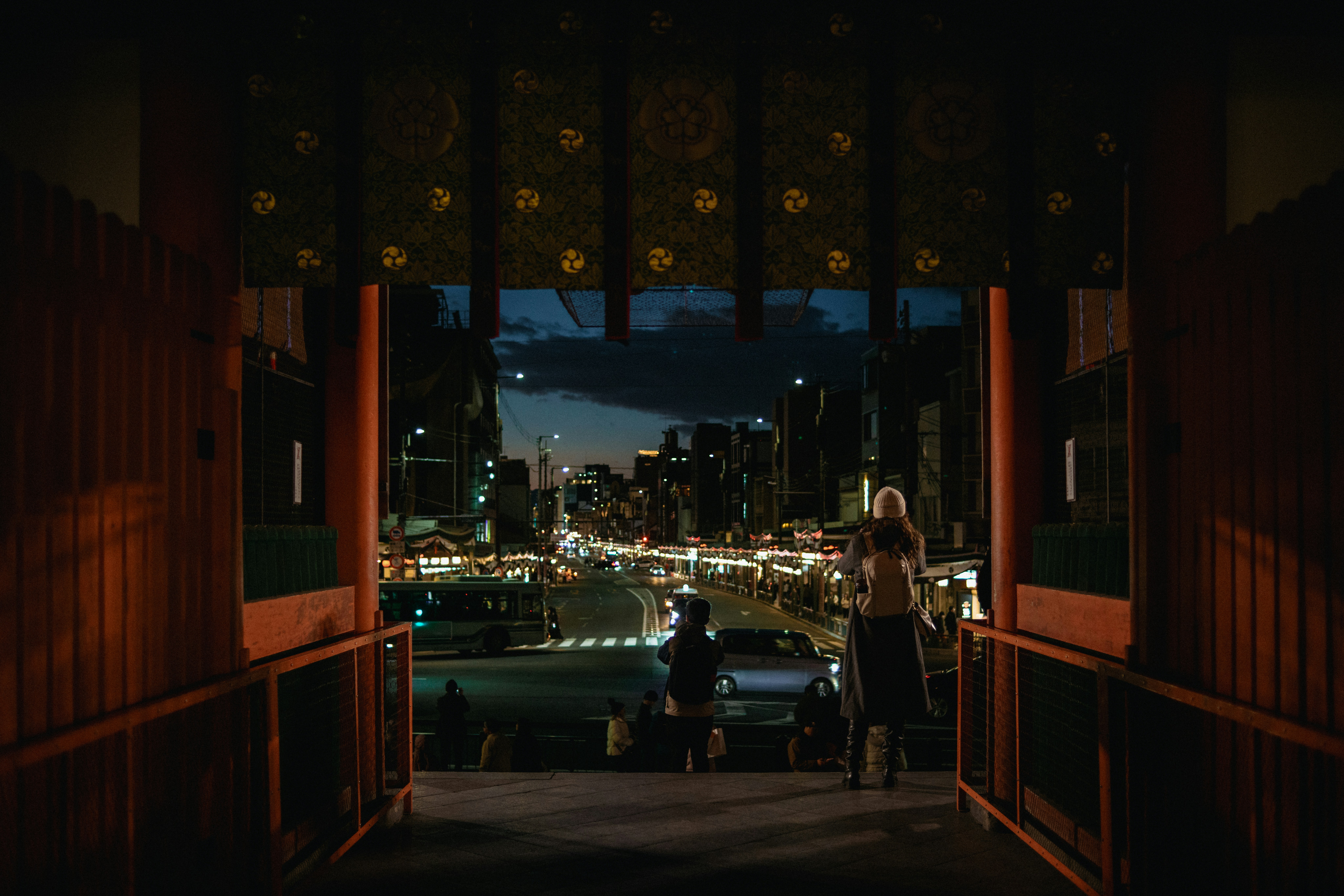 City Threshold: Nightlife Framed by a Shrine Gate