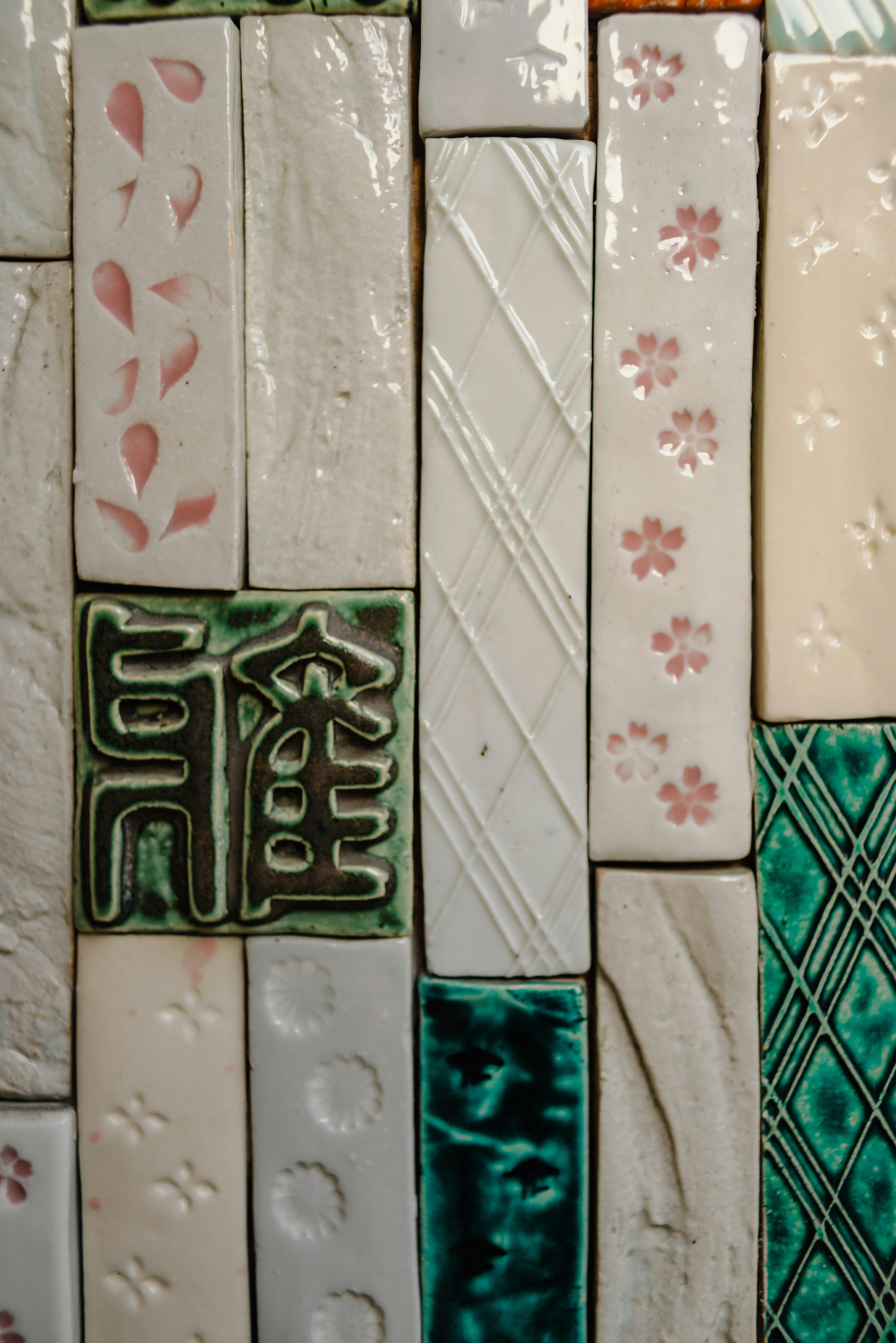 Silent Mosaic: Close-up of Decorative Tiles with Subtle Floral Impressions