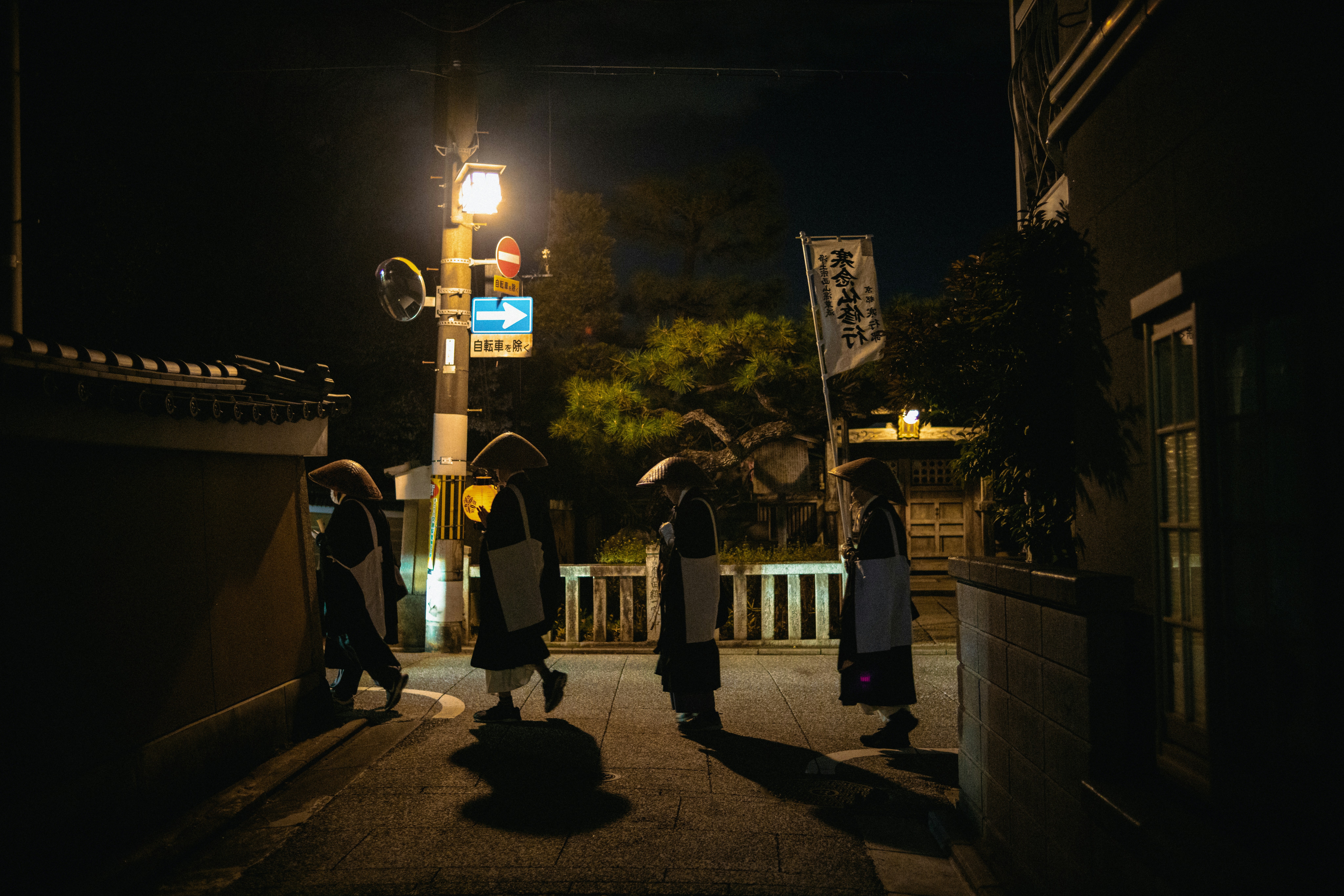 Evening procession beneath a quiet streetlamp