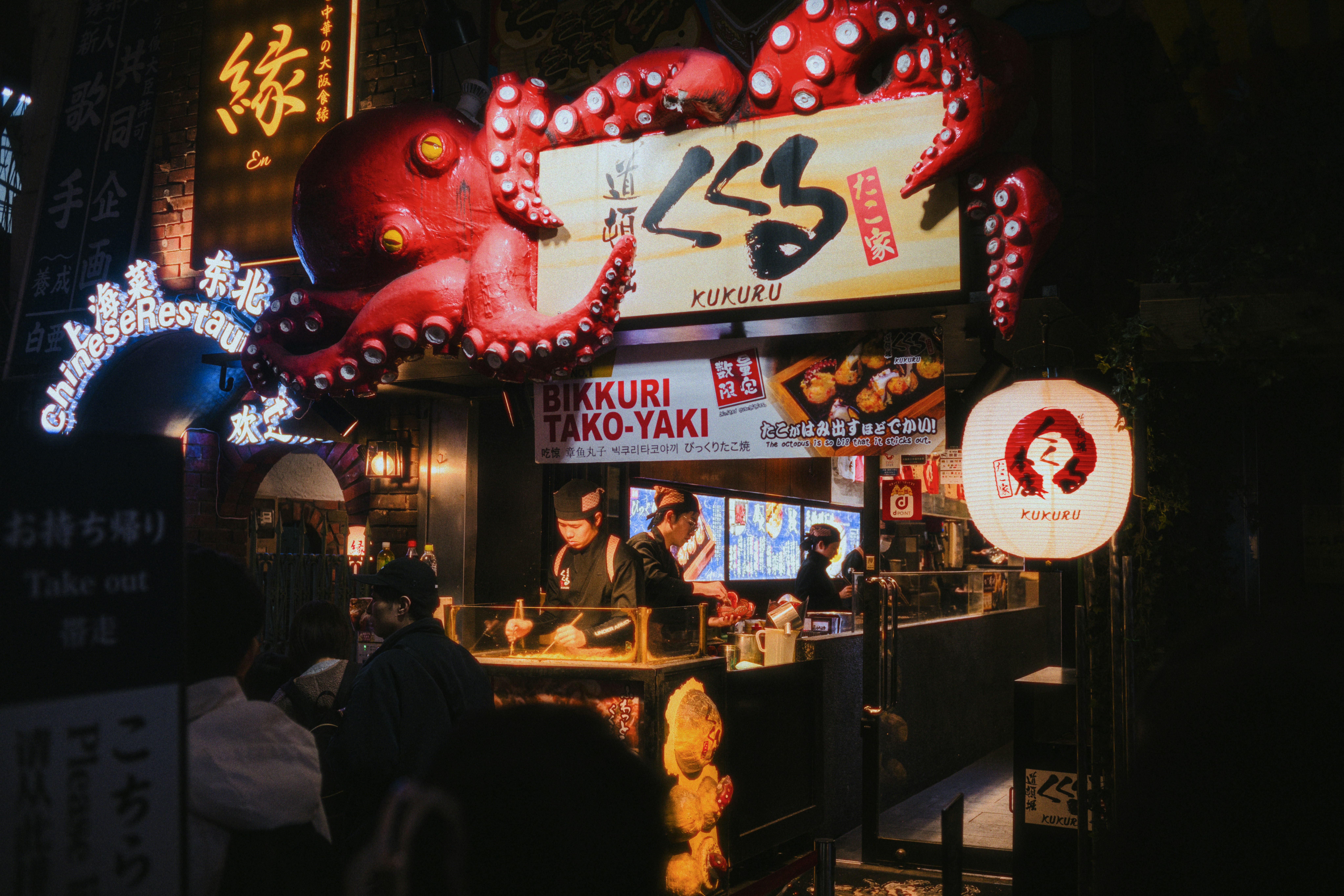 Neon Night Food Stall Framed by a Playful Octopus Sign