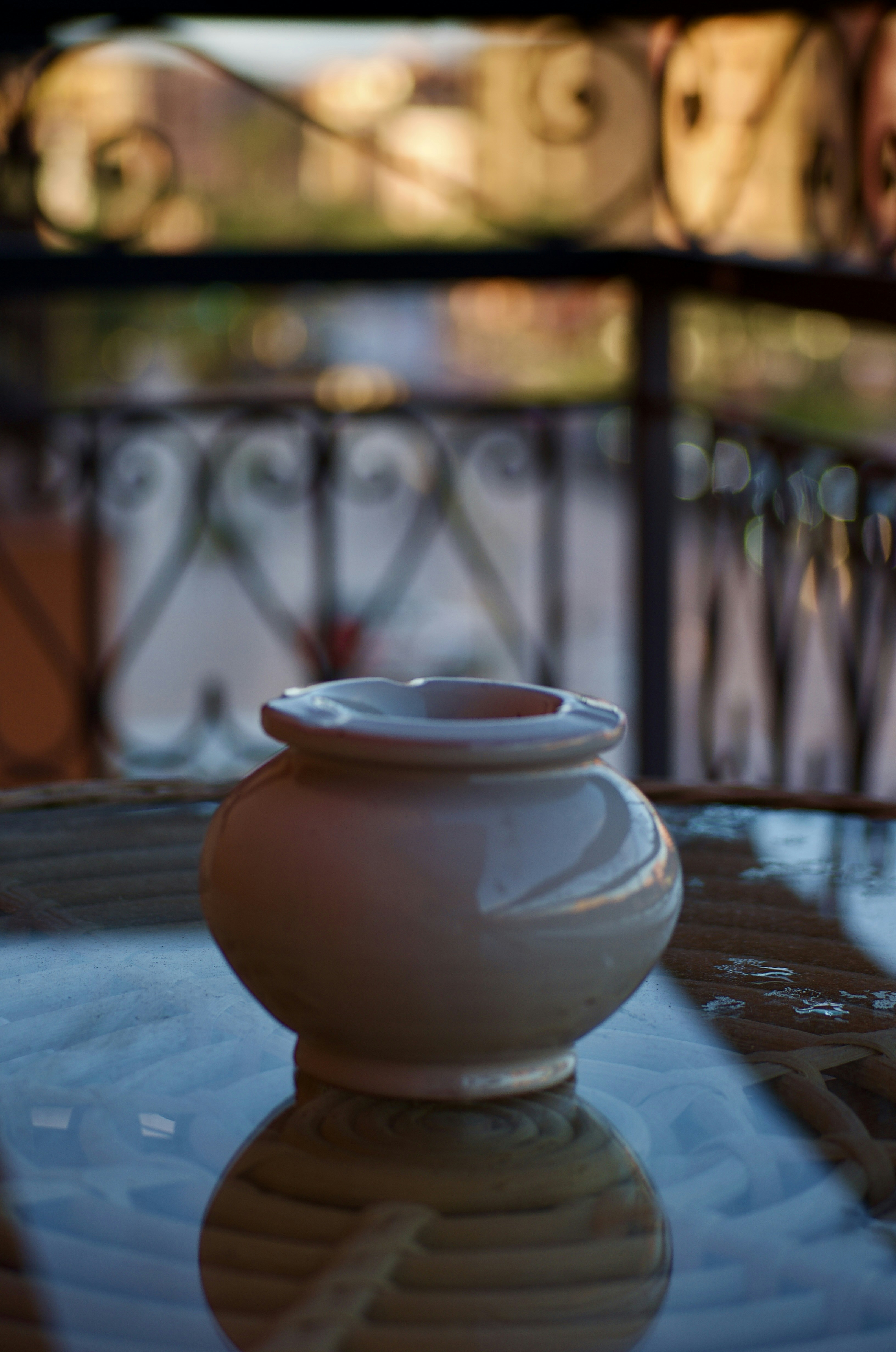 Ceramic Jar on Glass Table: Soft Twilight Light and Reflections