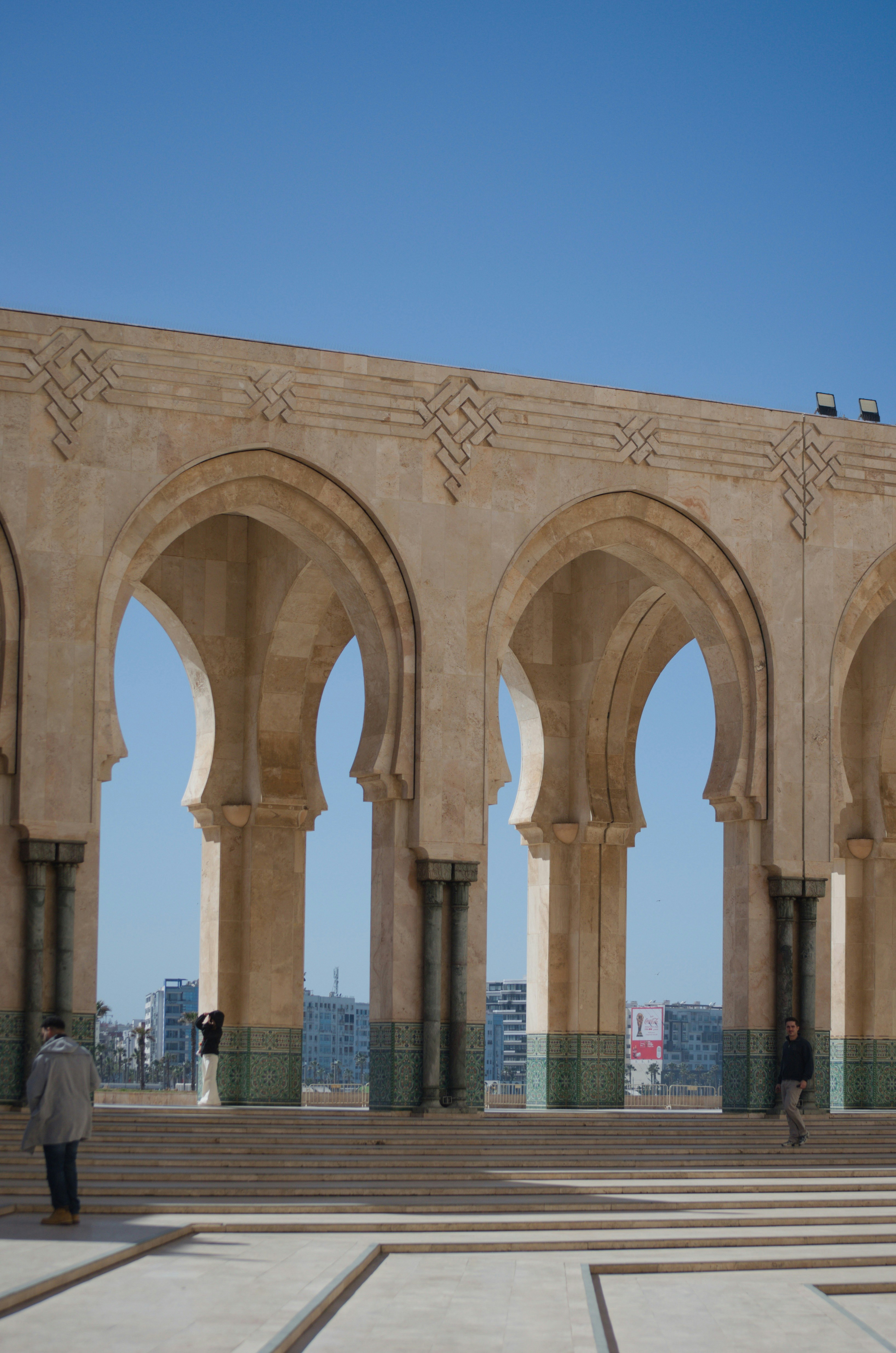 Arched Colonnade and Blue Sky Over Sea-Front Plaza