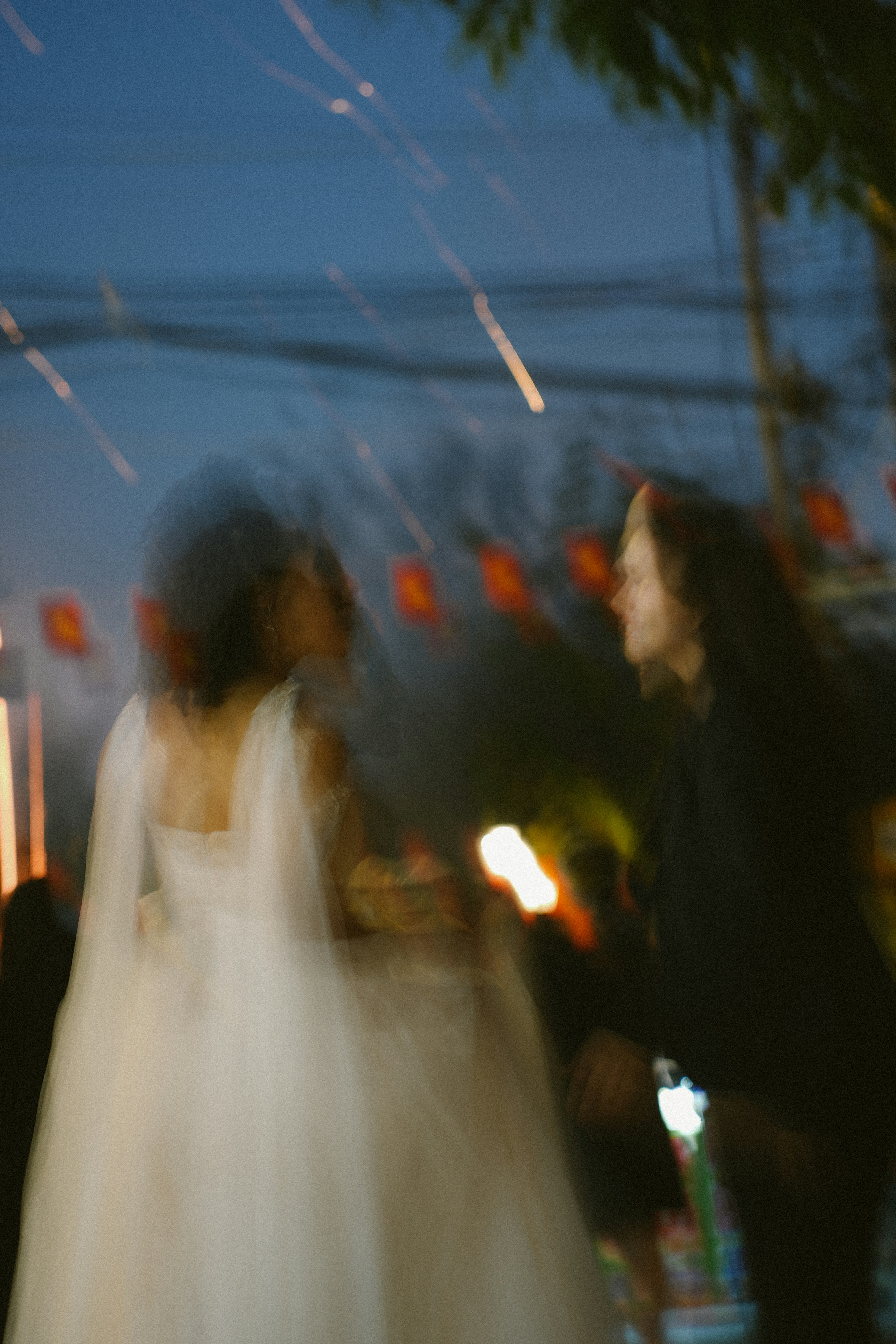 Blurred Lights, Sharp Moment: Two Figures in Motion at Dusk