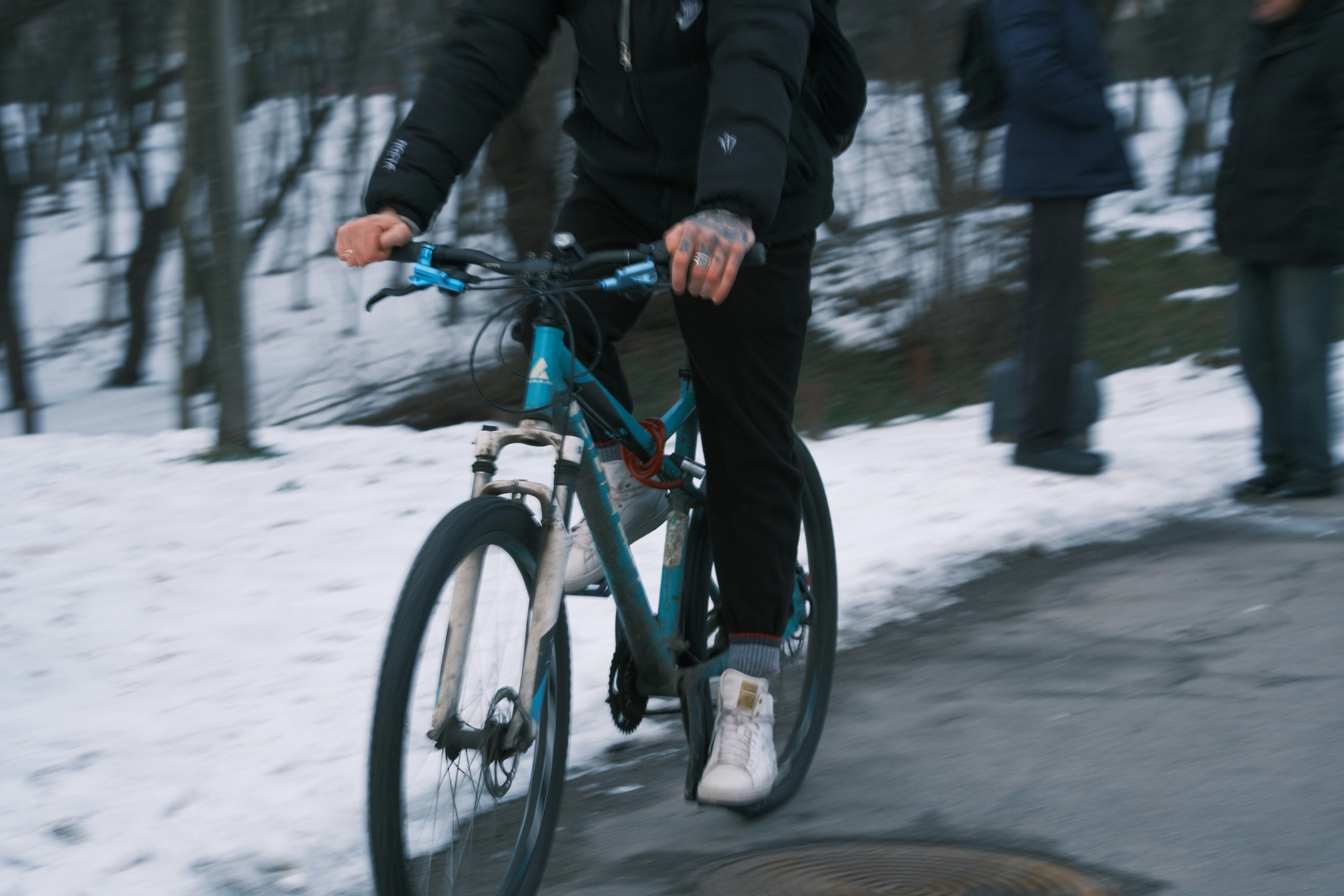Mid-Stride on a Snowy Path: Cyclist in Motion