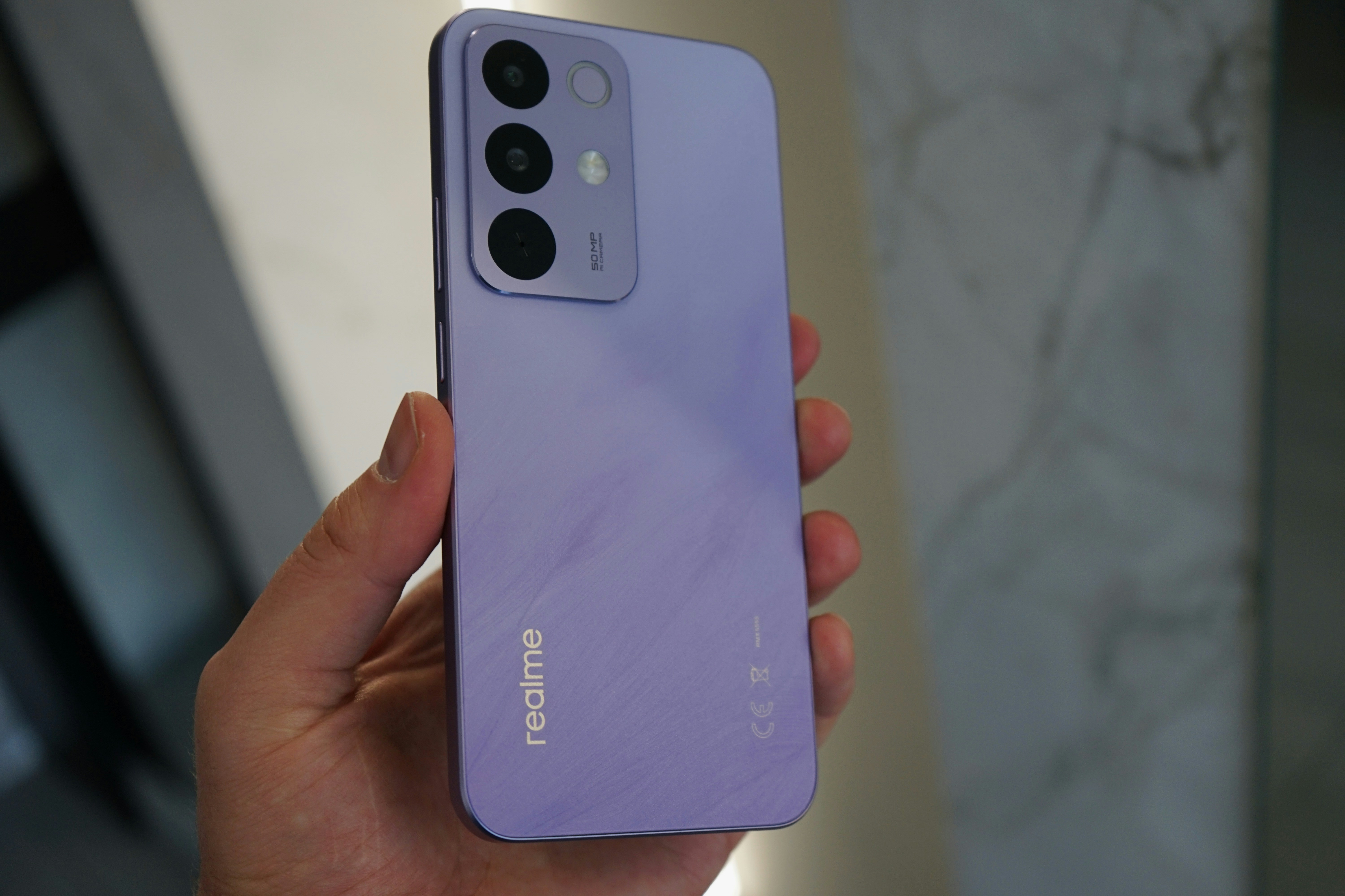 Purple Realme in Hand: A Close-Up Portrait of a Modern Smartphone