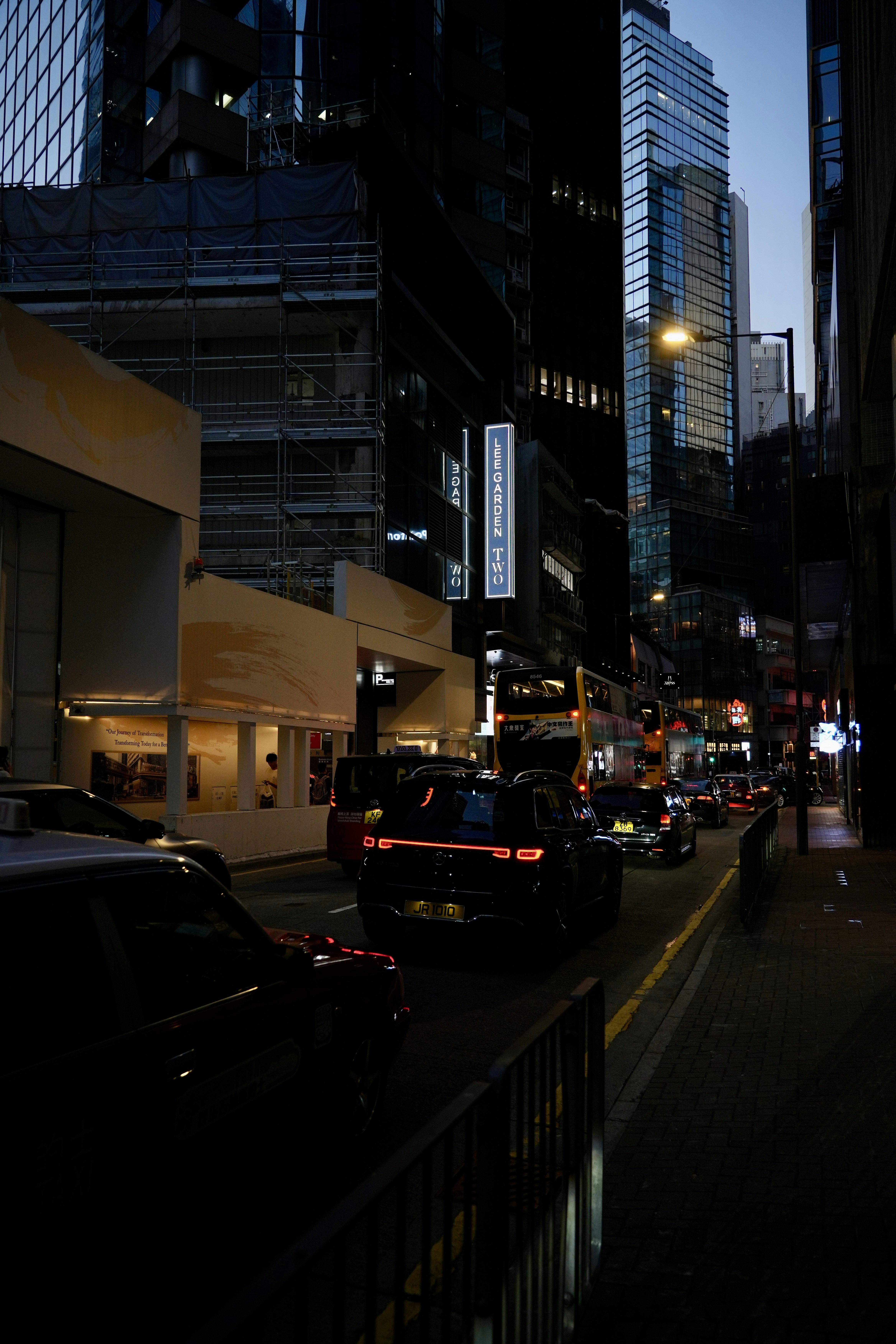 Night City Corridor: A Line of Cars and Neon Between Skyscrapers