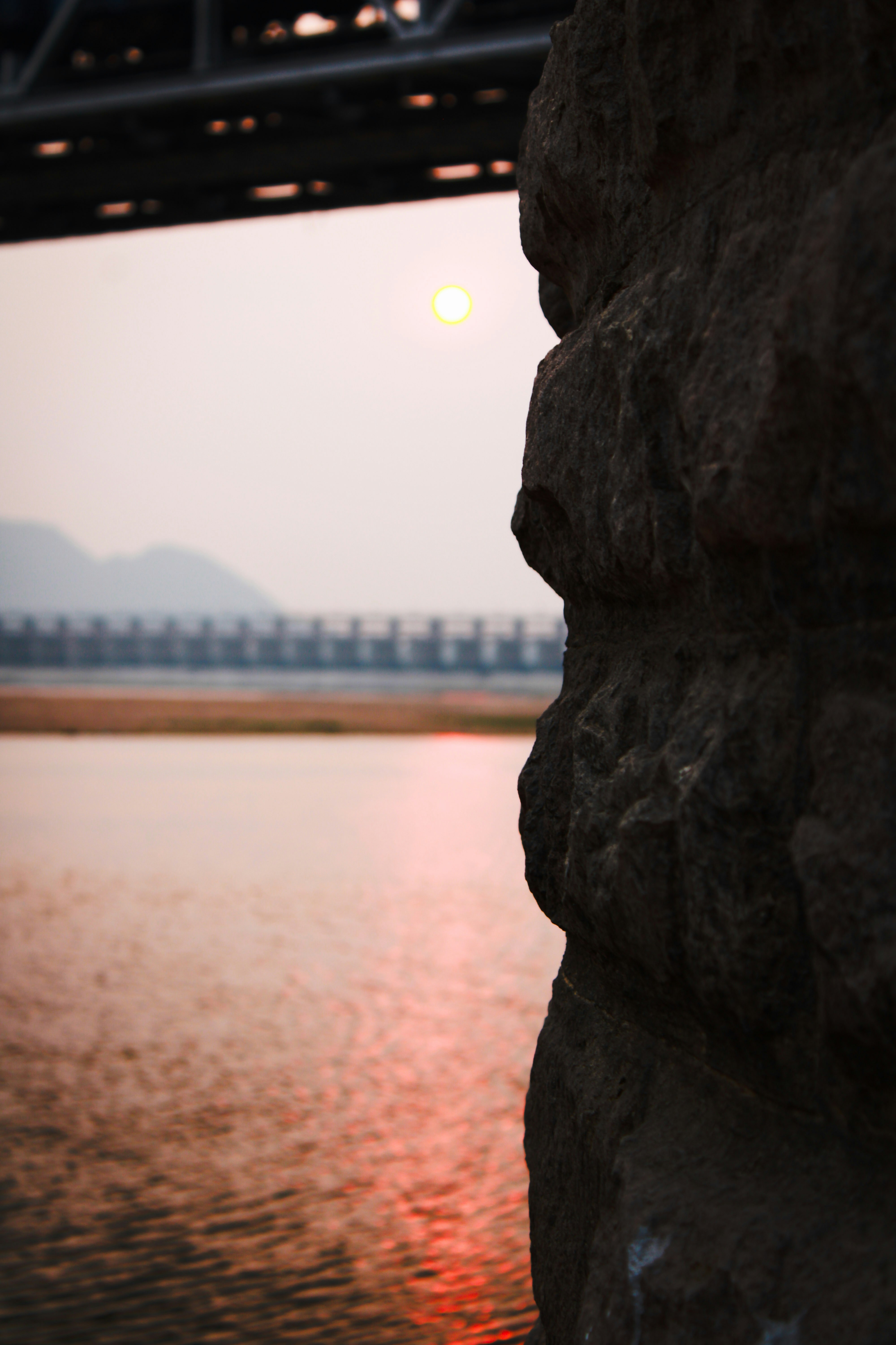 Sunlit Edge: A Pier and Stone Wall Framing a Quiet Waterfront