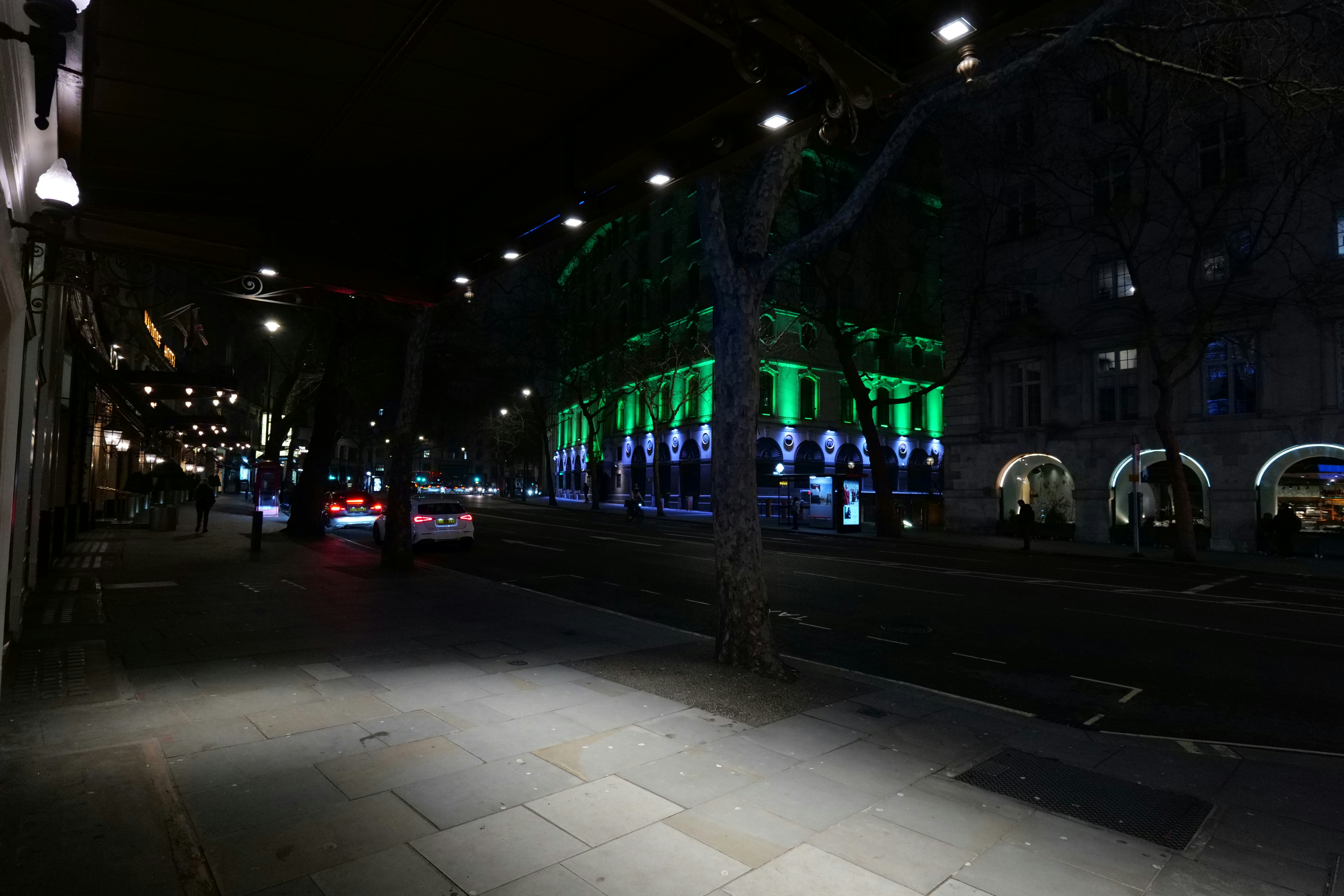 Neon Lane: Night Street with Green-Illuminated Facade