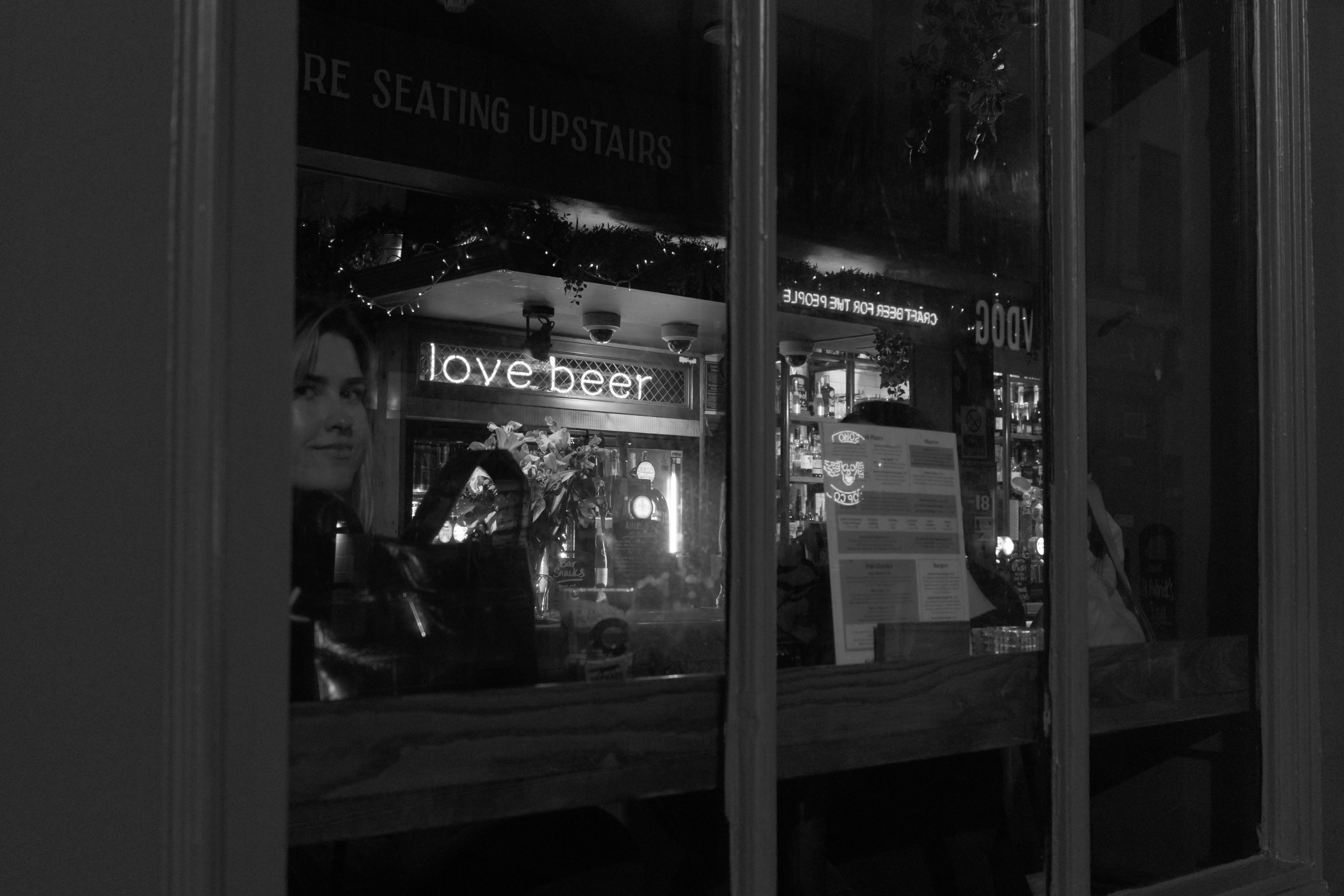 Neon Glow Through a Bar Window at Night