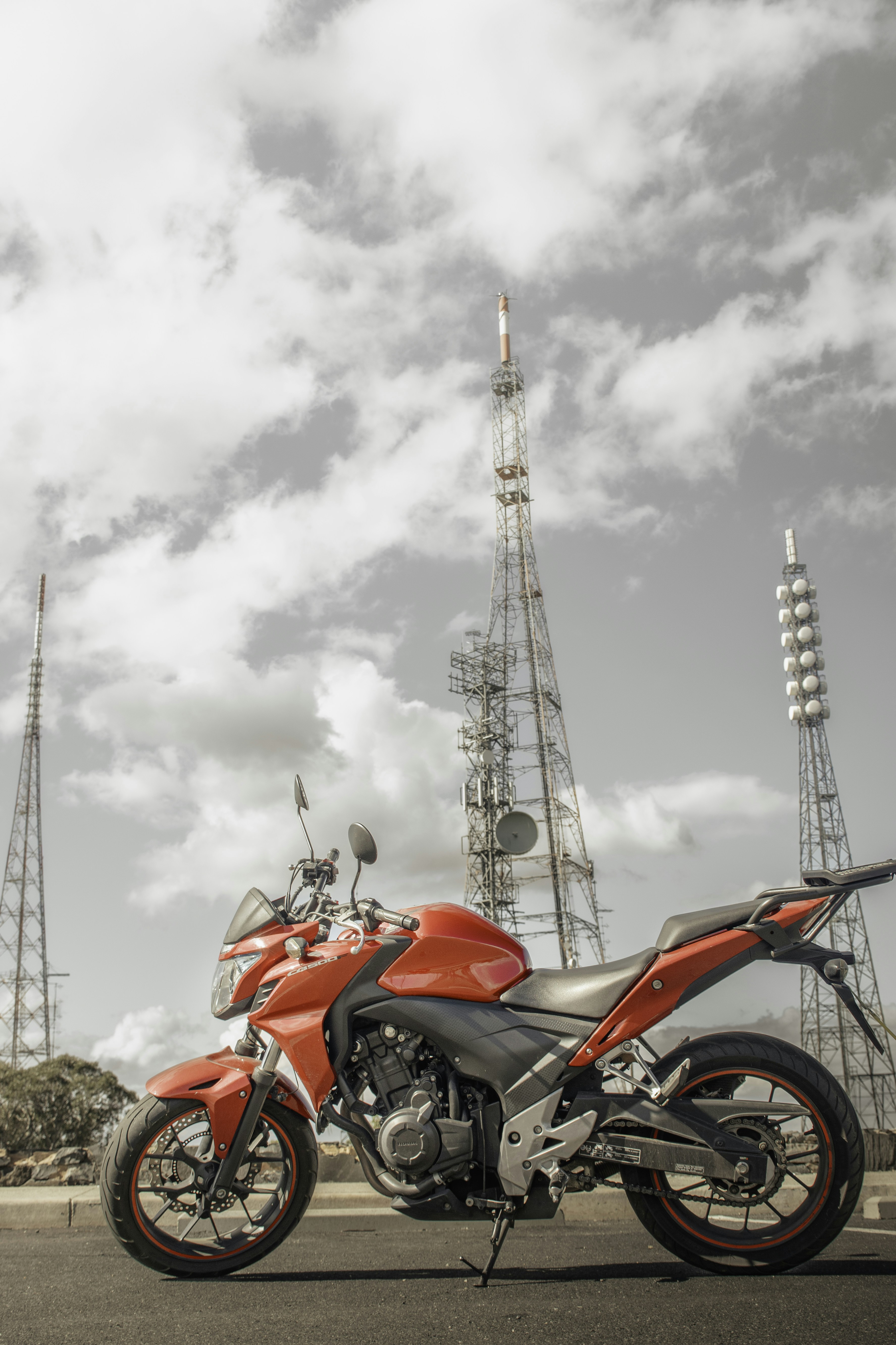 Red Stallion at the Towered Gate: A Street-Ready Ride Under Tall Masts