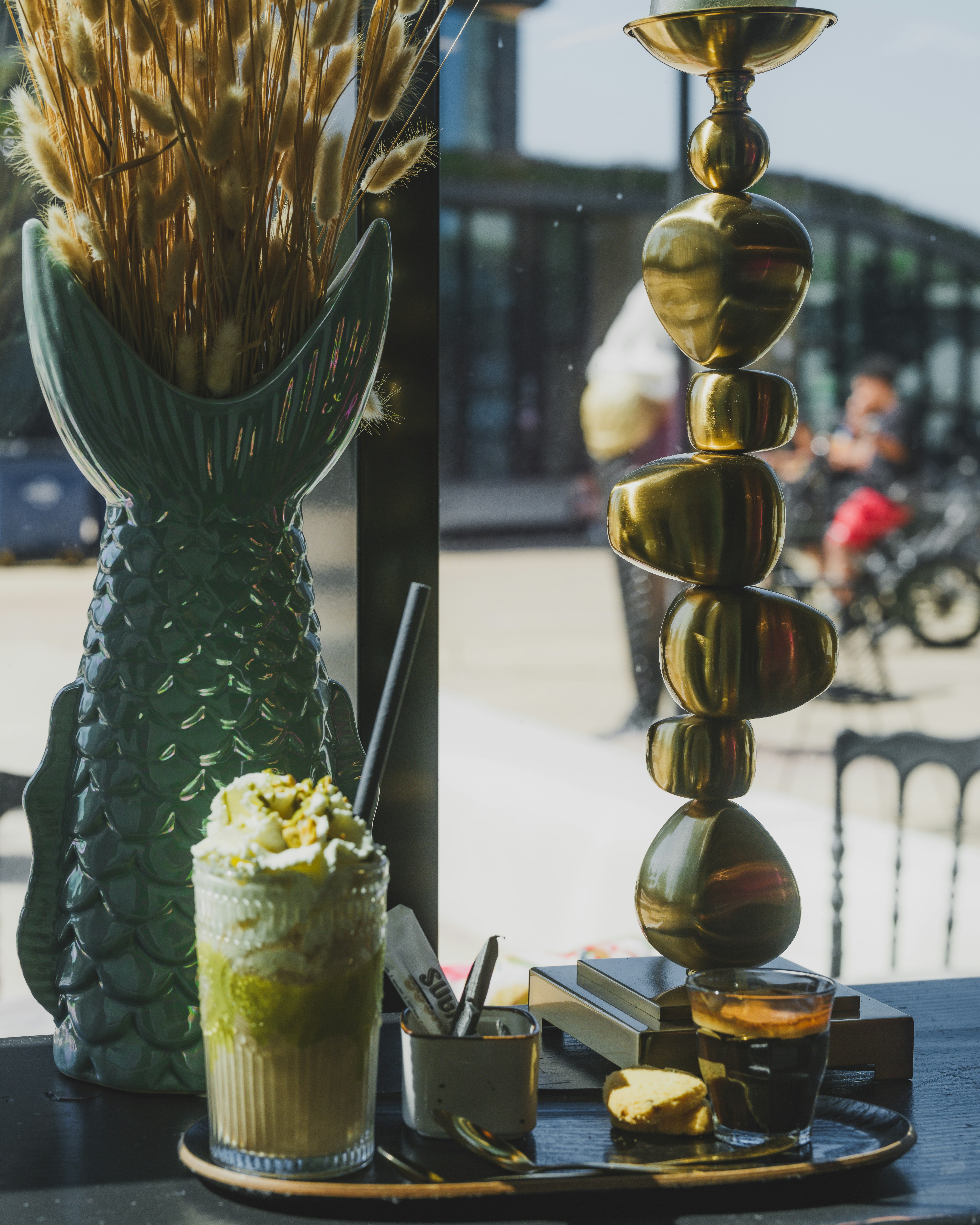 Heritage Sprigs and Sugar Glass: A Café Still Life Framed by Sunlit Street