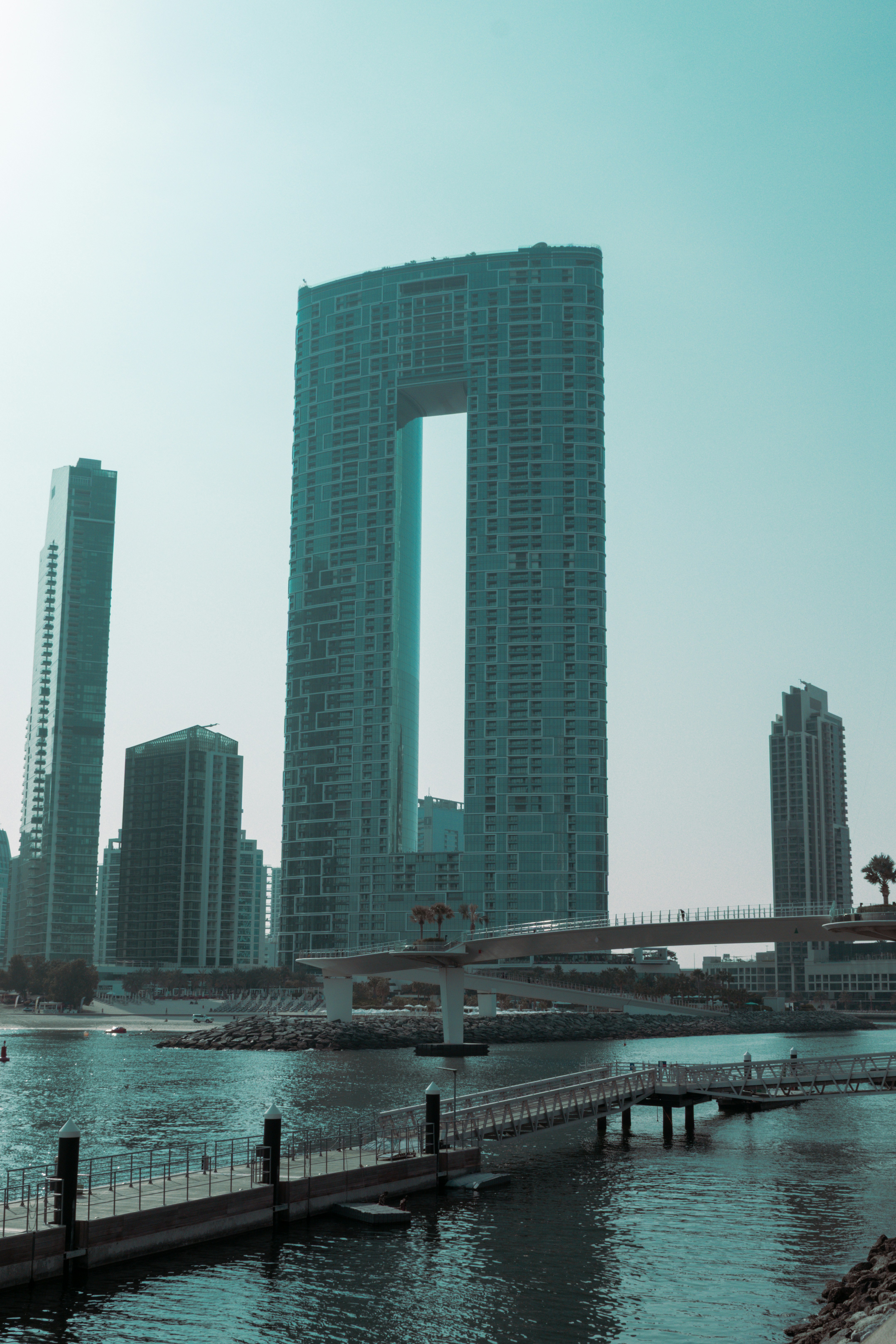 Archway of Glass: Dubai’s Echoing Skyline by the Waterfront
