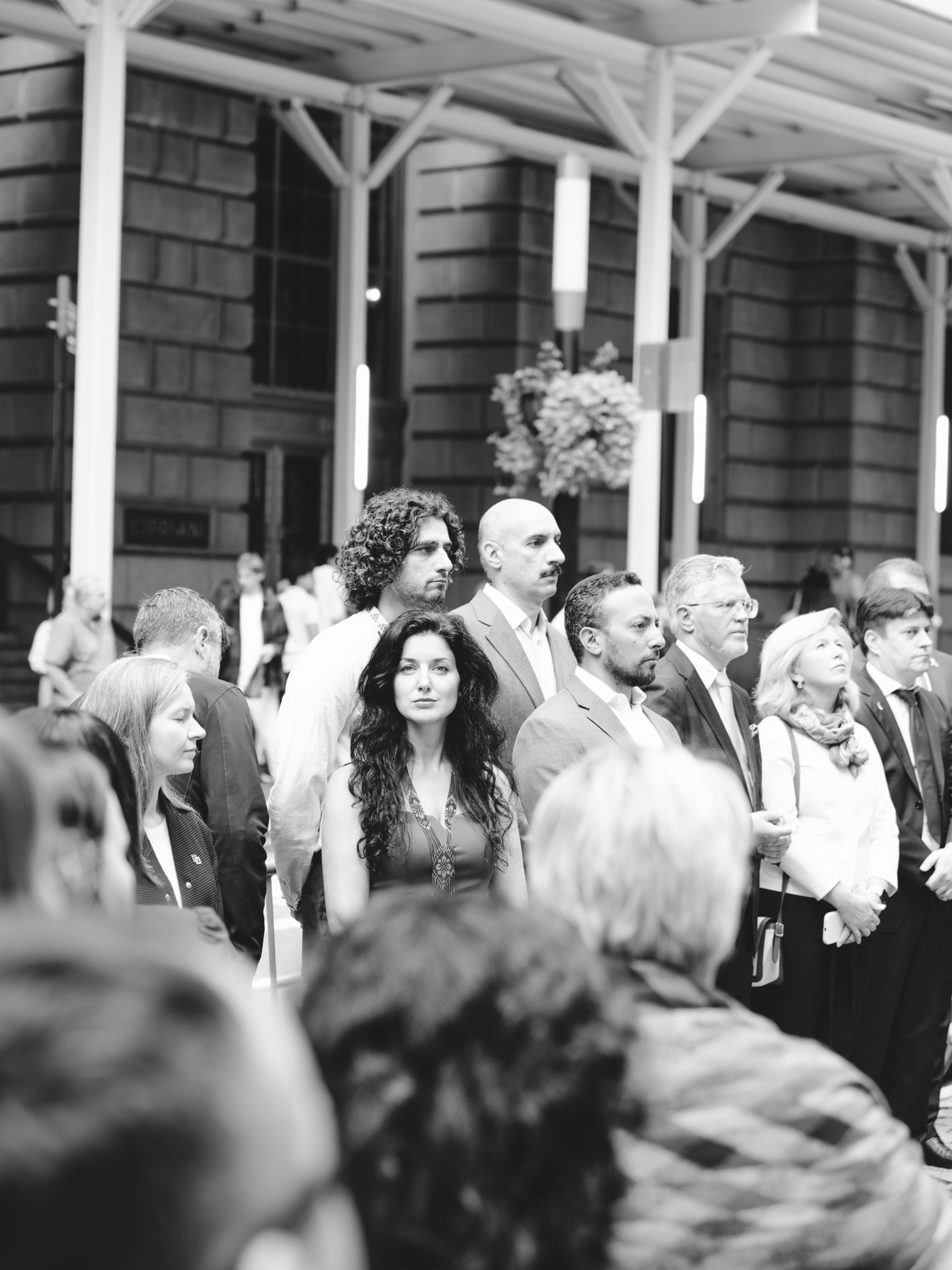 Center Stage: A Formal Crowd Gathers Under Urban Canopy