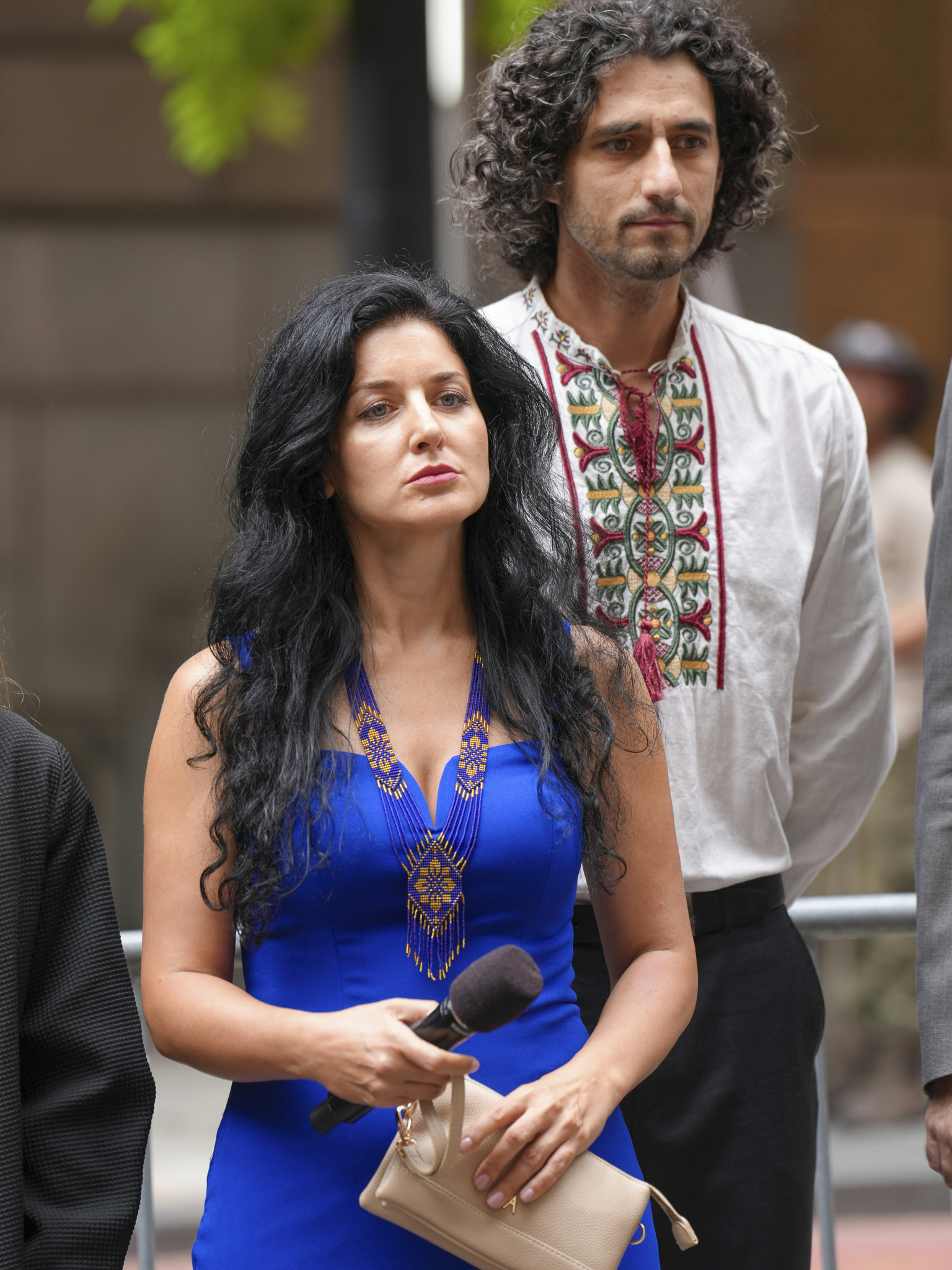 Blue dress, quiet resolve: a duo in city fashion