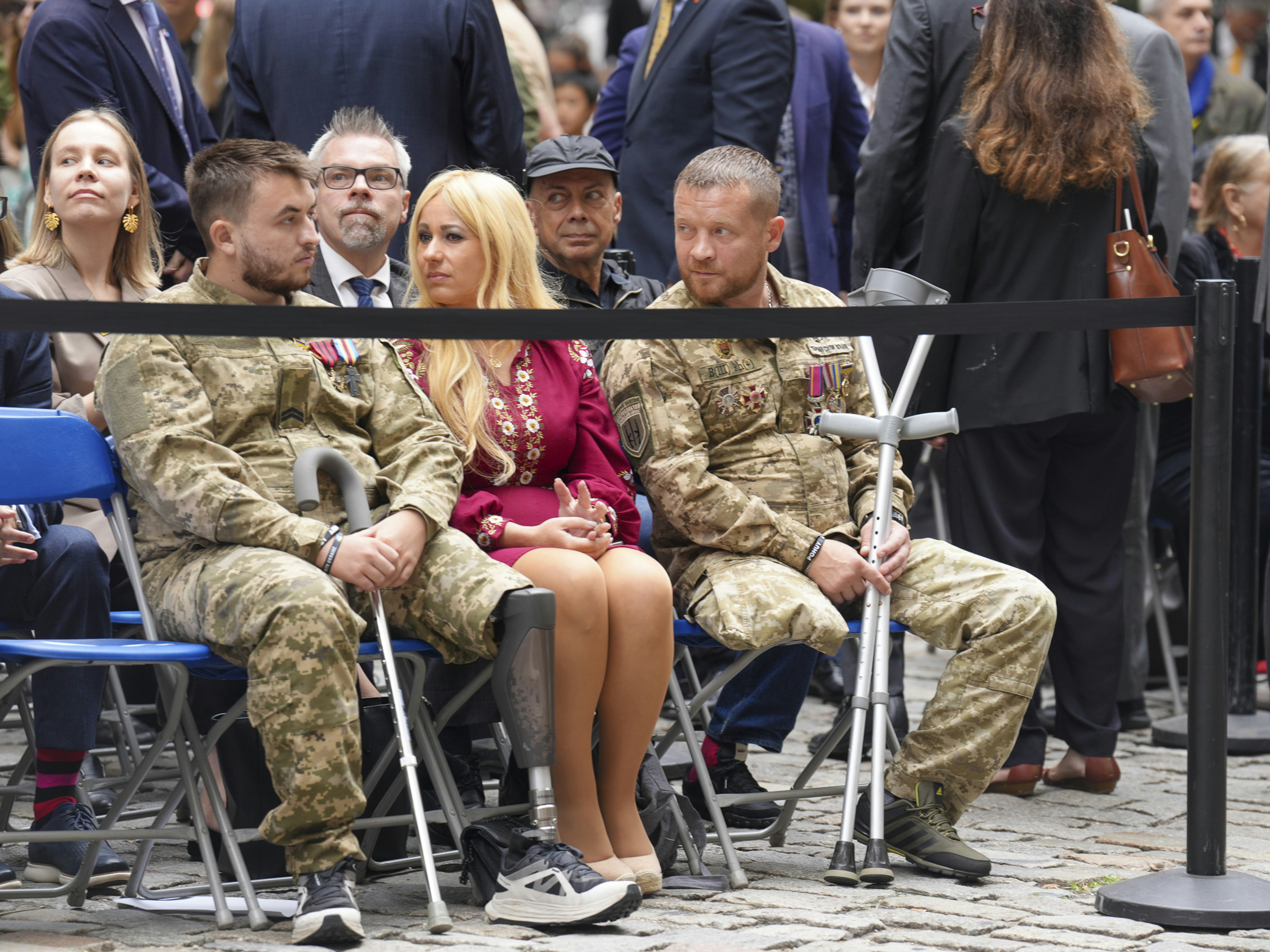 Military Personnel Guarded by Civilians at a Public Event