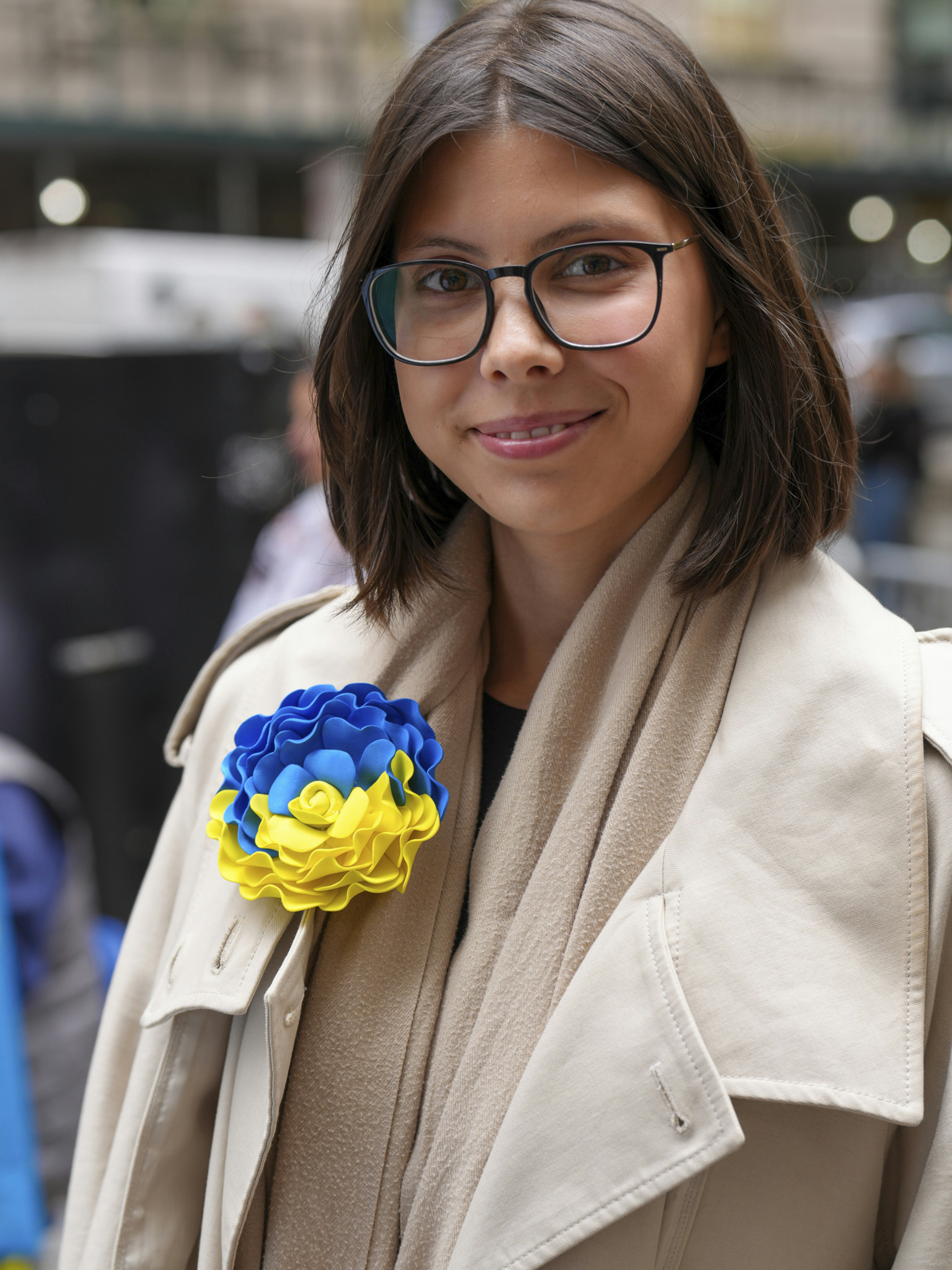 Smiling Portrait with a Bright Floral Accent on a City Street