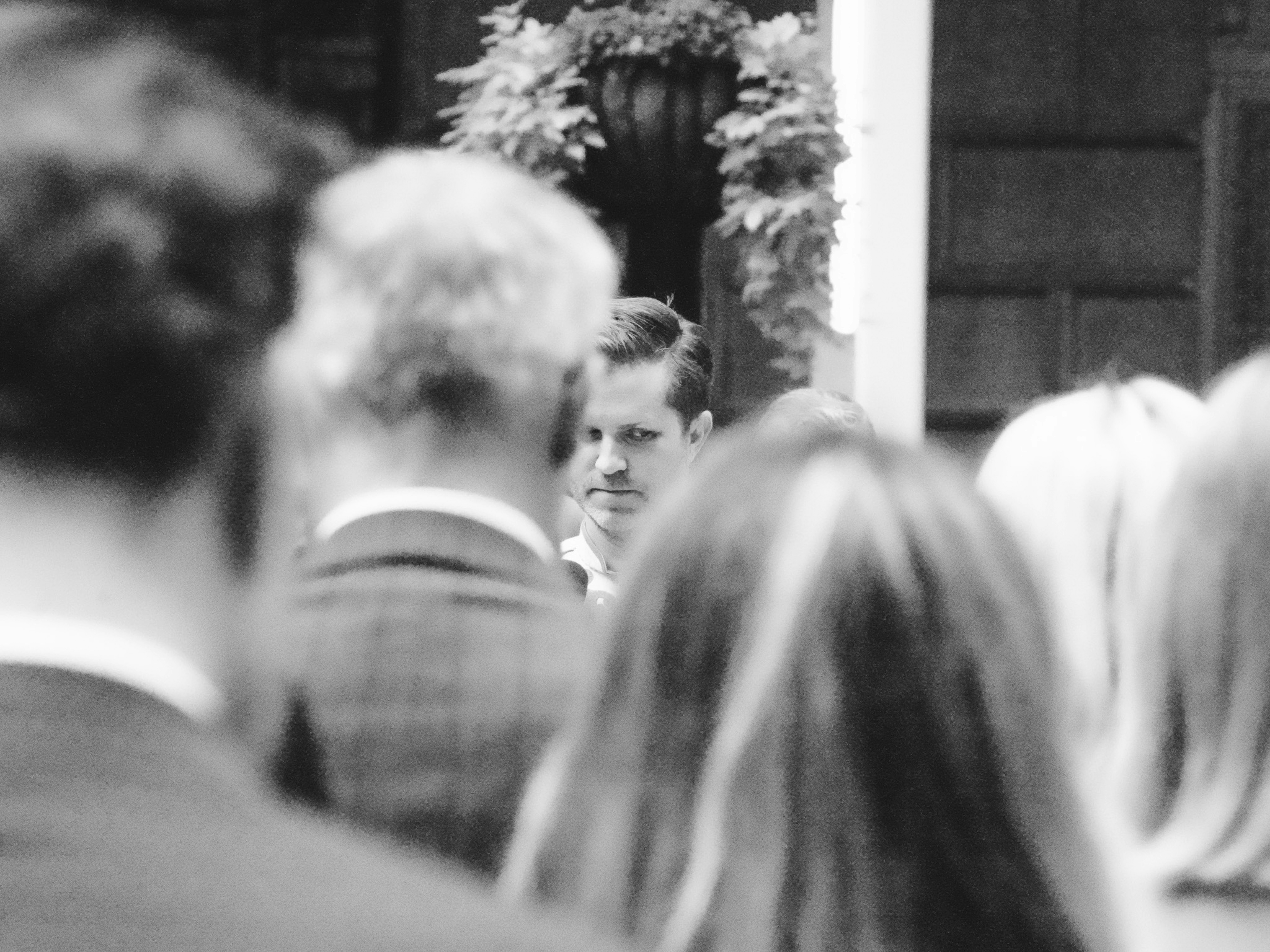 Eyes in the Crowd: A Quiet Gaze Emerges from the Backlit Assembly