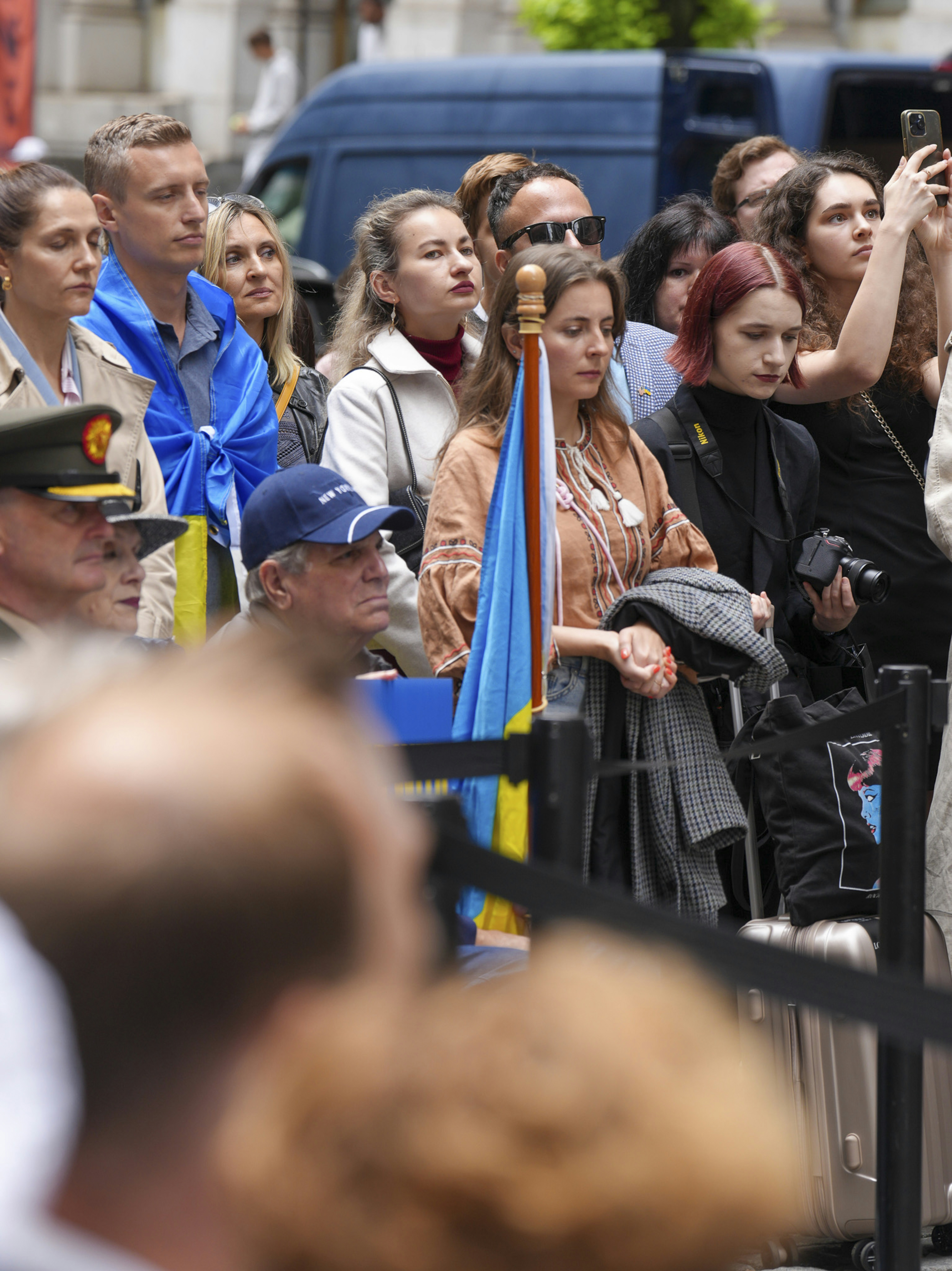 Climactic Crowd at a Public Event Framing a Blue-and-Yellow Banner