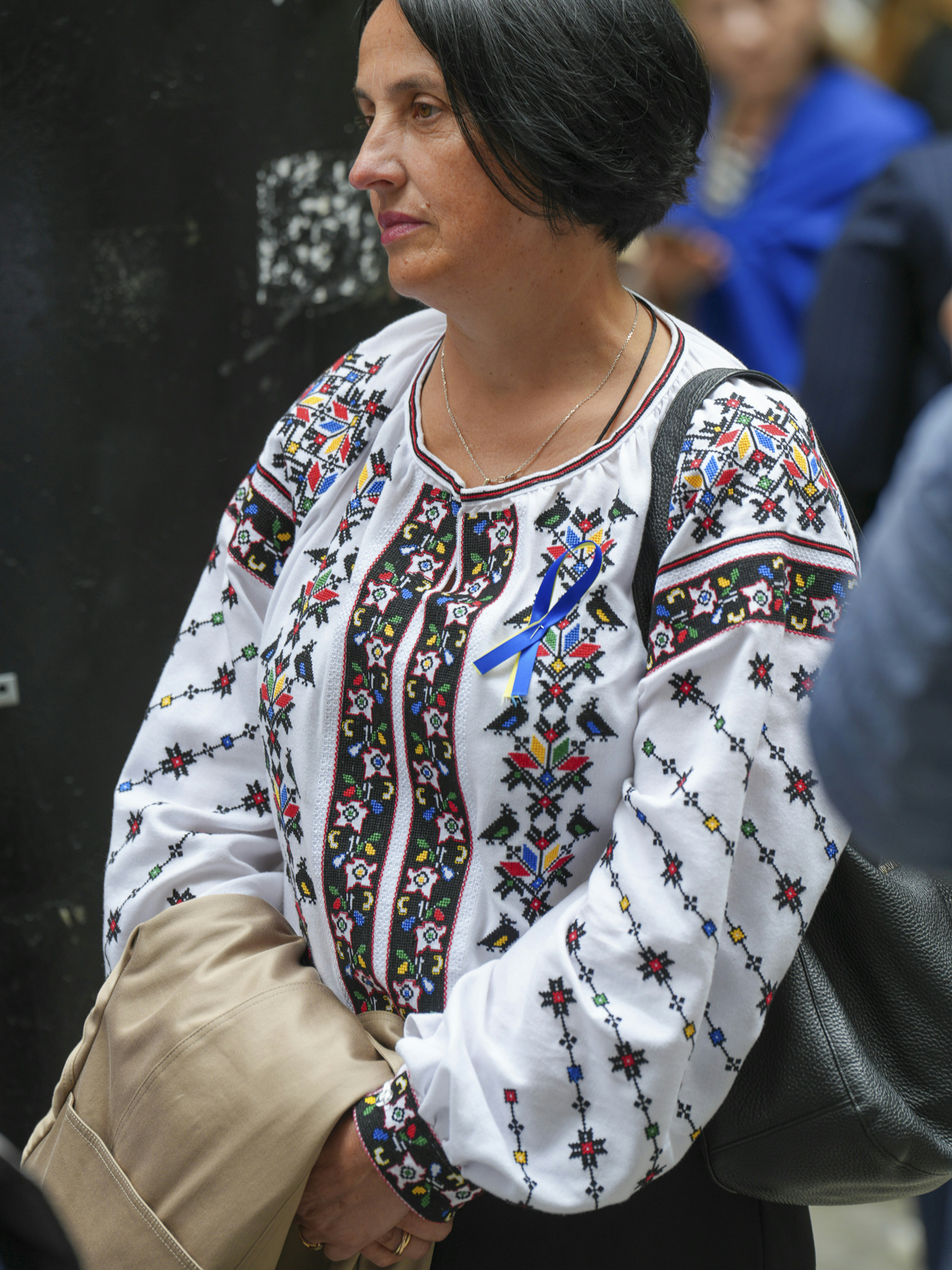 Portrait of a Ukrainian-inspired embroidered blouse with a blue ribbon