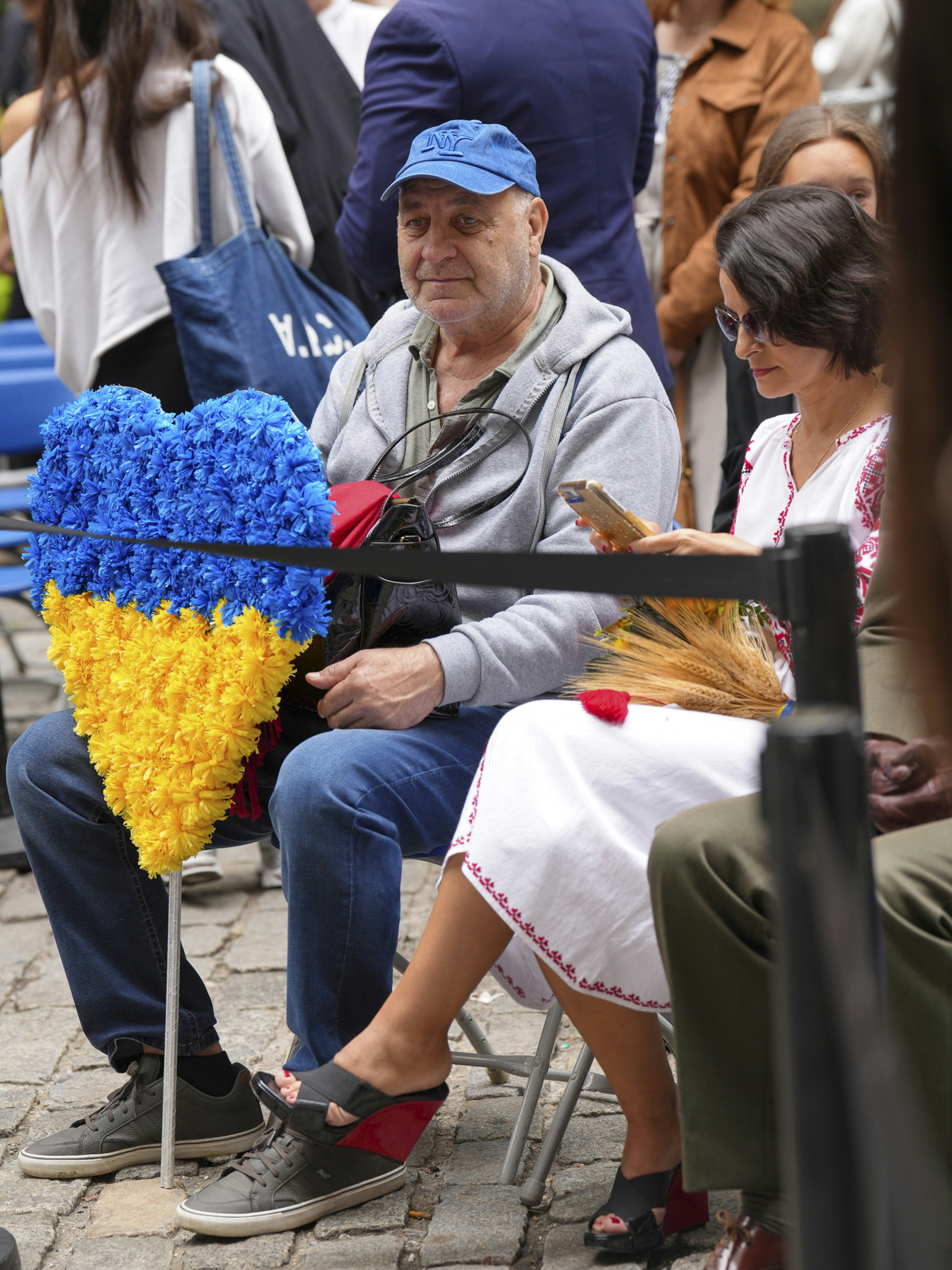 The Kneeling Honoree with Bright Heart Cape