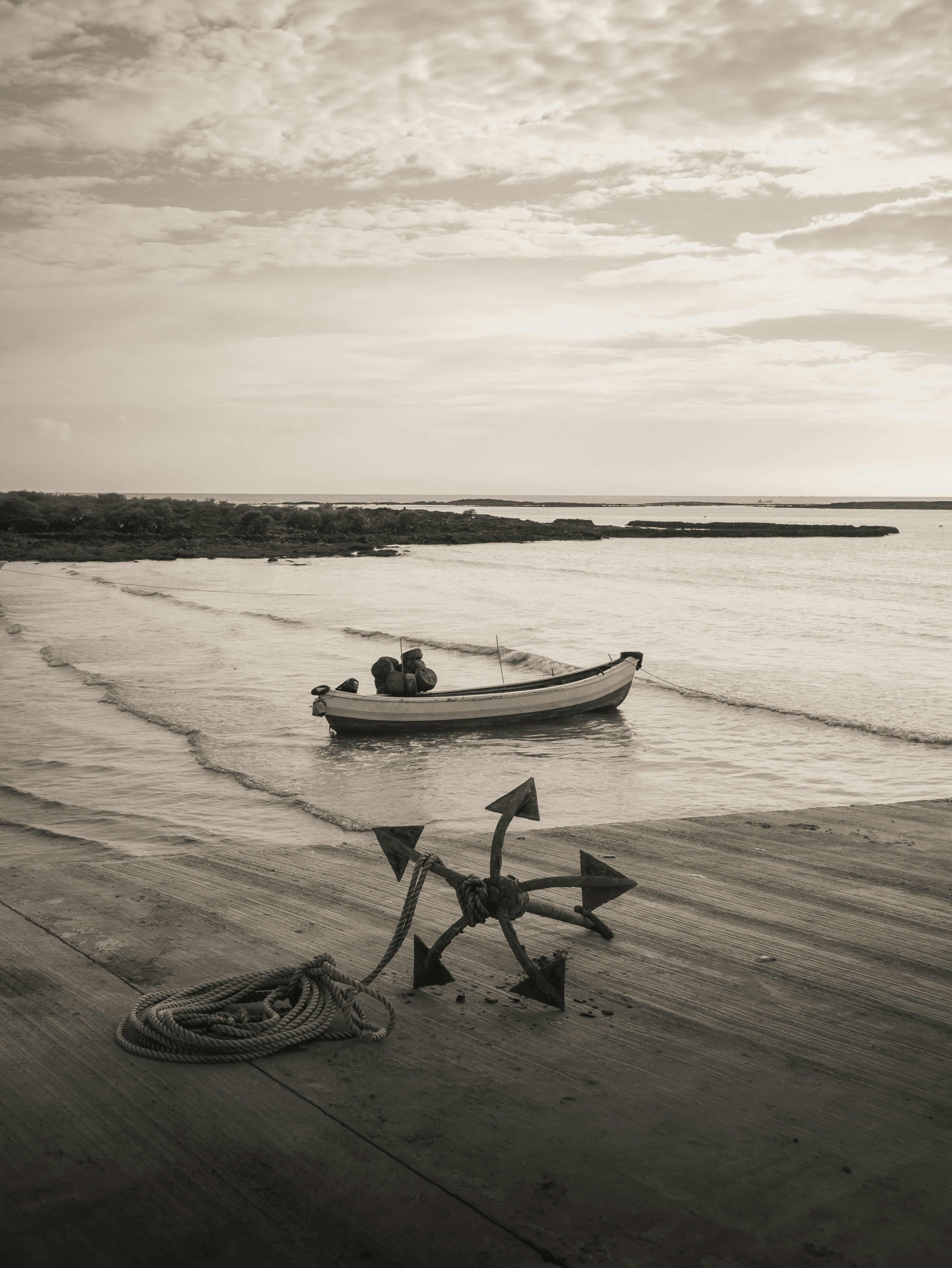 A Quiet Boat and Sea Rake at Dusk