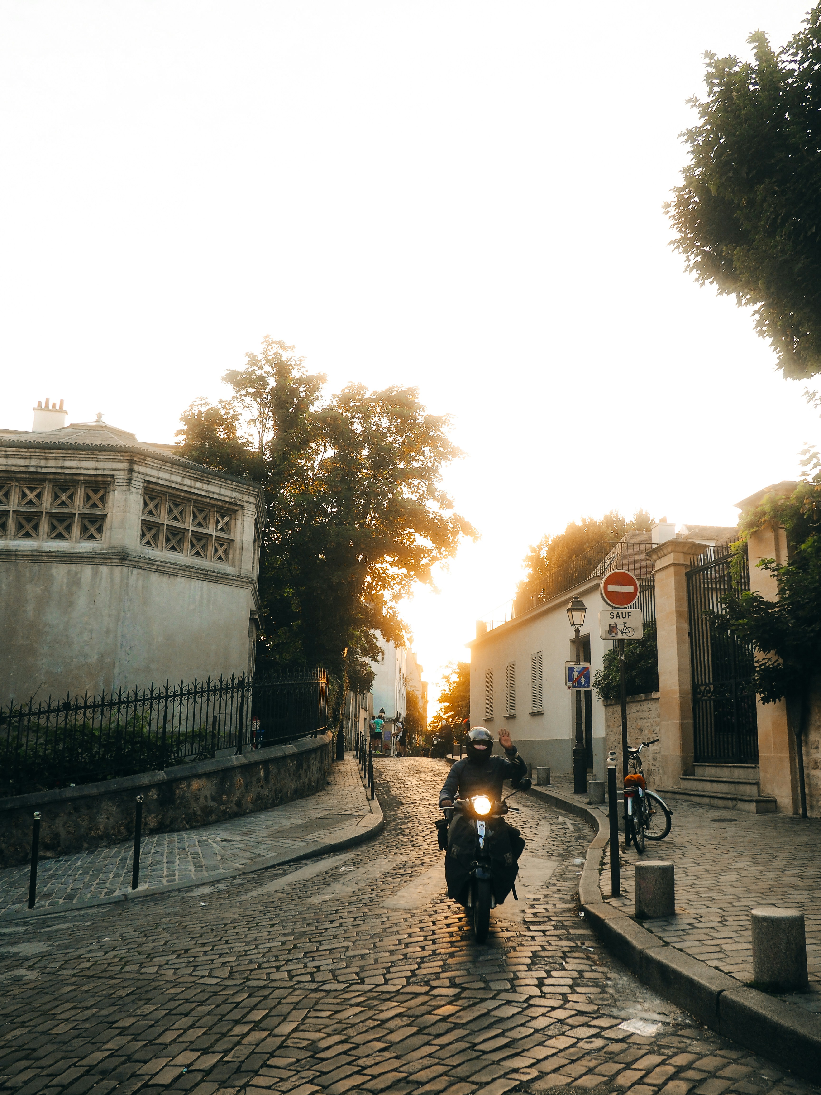 Sunlit Cobbled Street Ride at Dusk