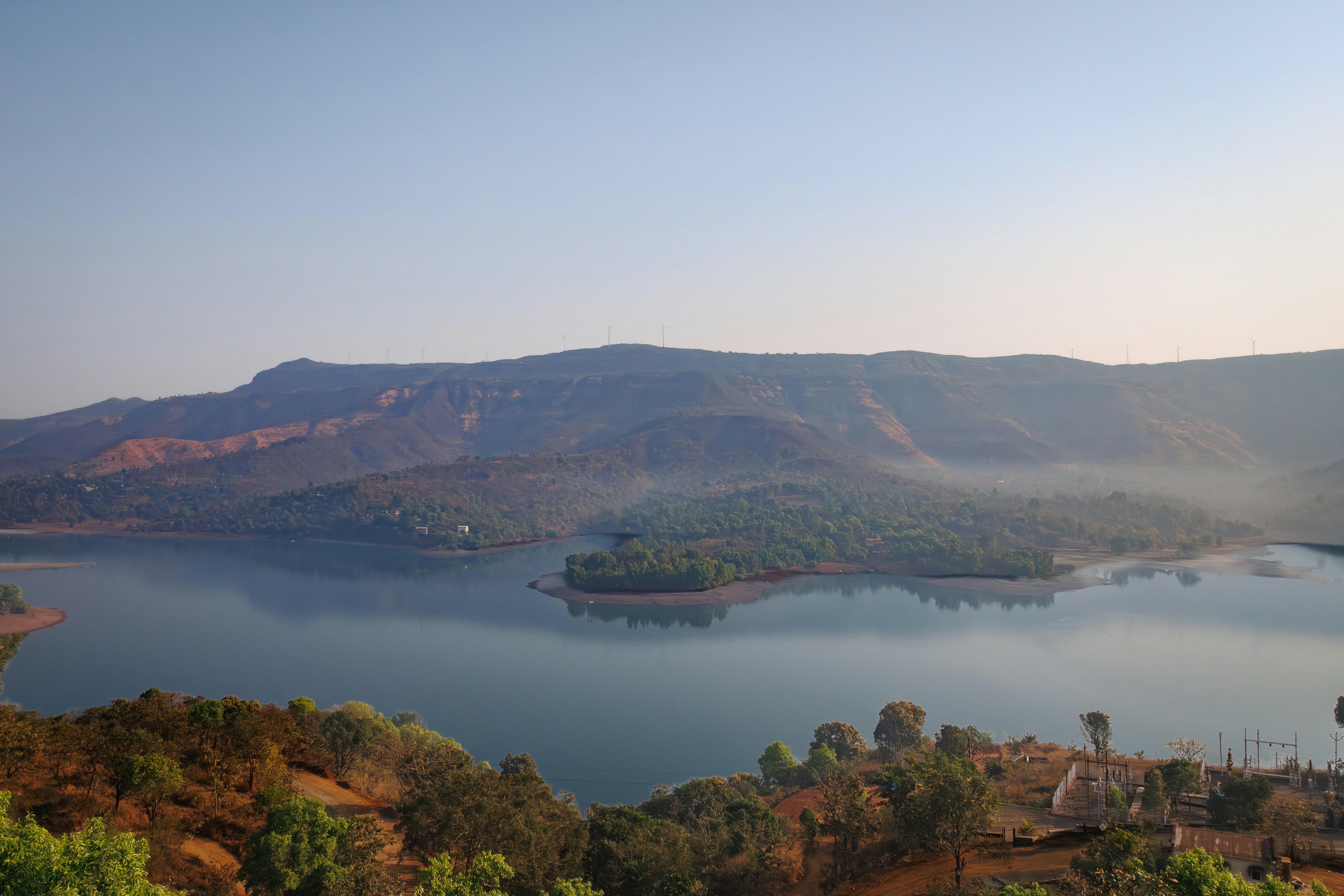 Serene Lake Panorama Framed by Distant Hills at Dusk