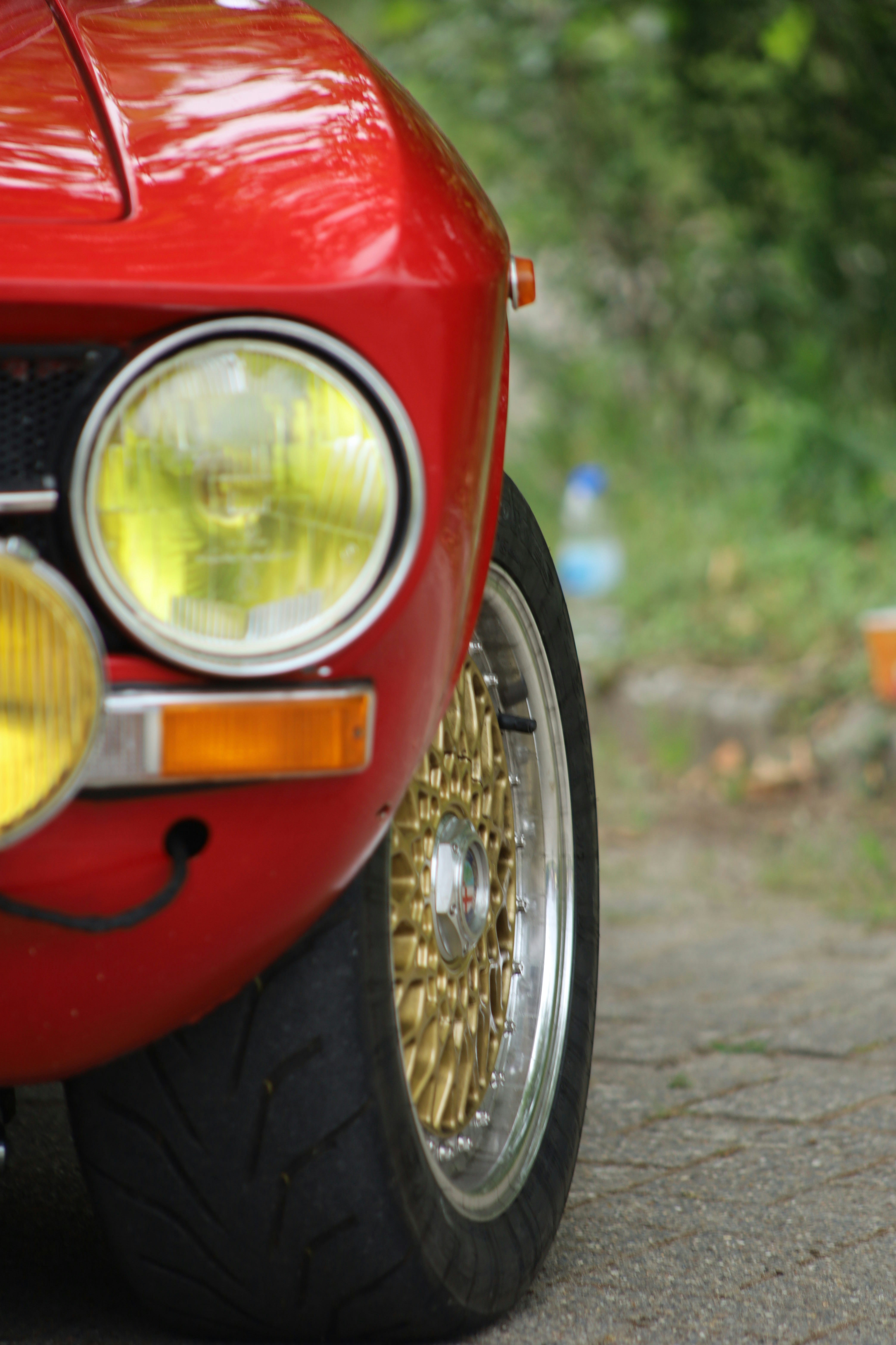 Red Car, Golden Wheels: A Close-Up of Classic Detail