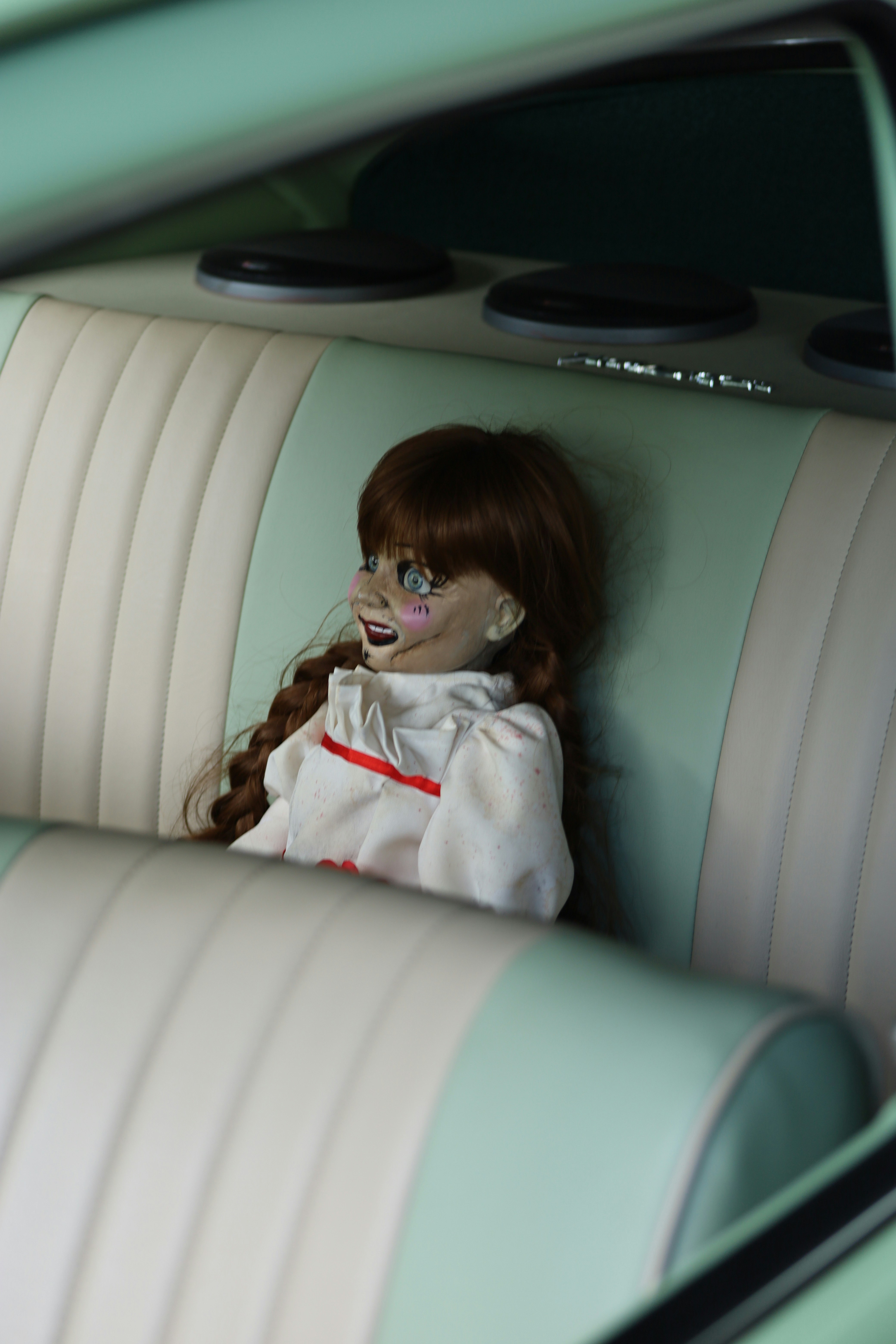 Haunting Doll in a Mint Car Seat: Quietly Observing the Drive