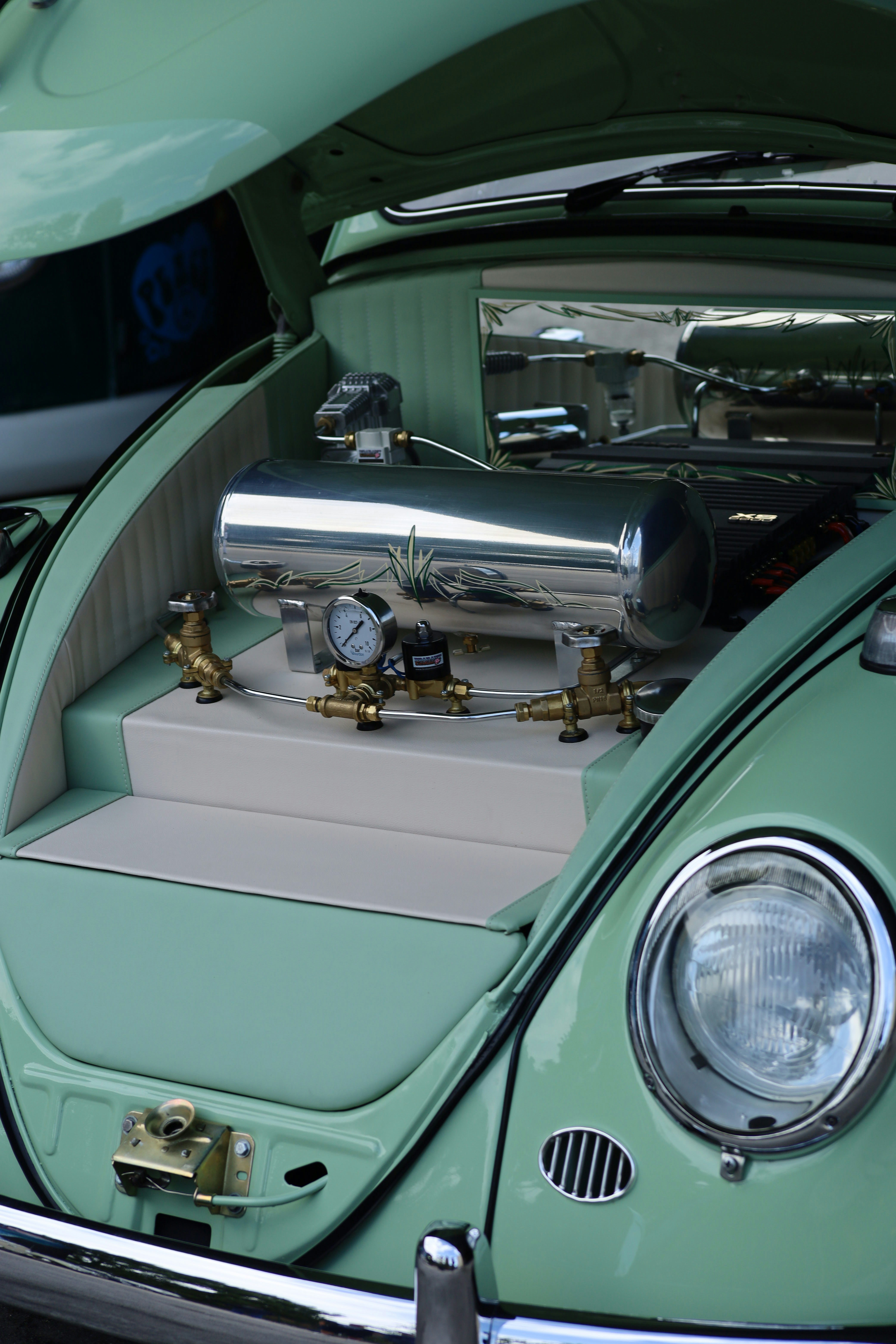Mint-green engine bay reveals a polished chrome fuel cell under a classic tail