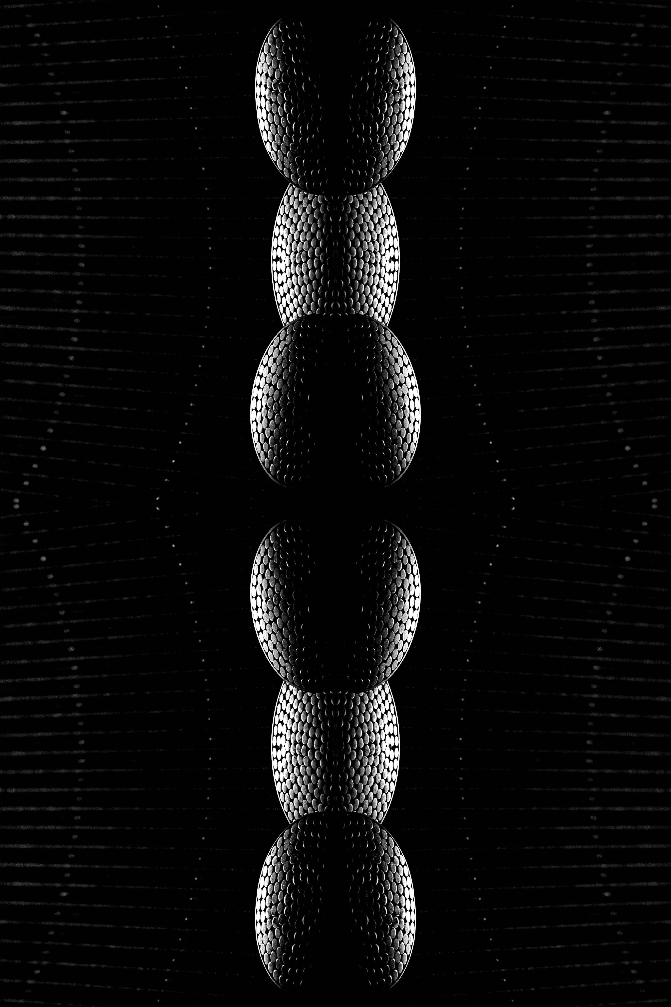 Symmetry in Black: A Tactile Column of Orbs