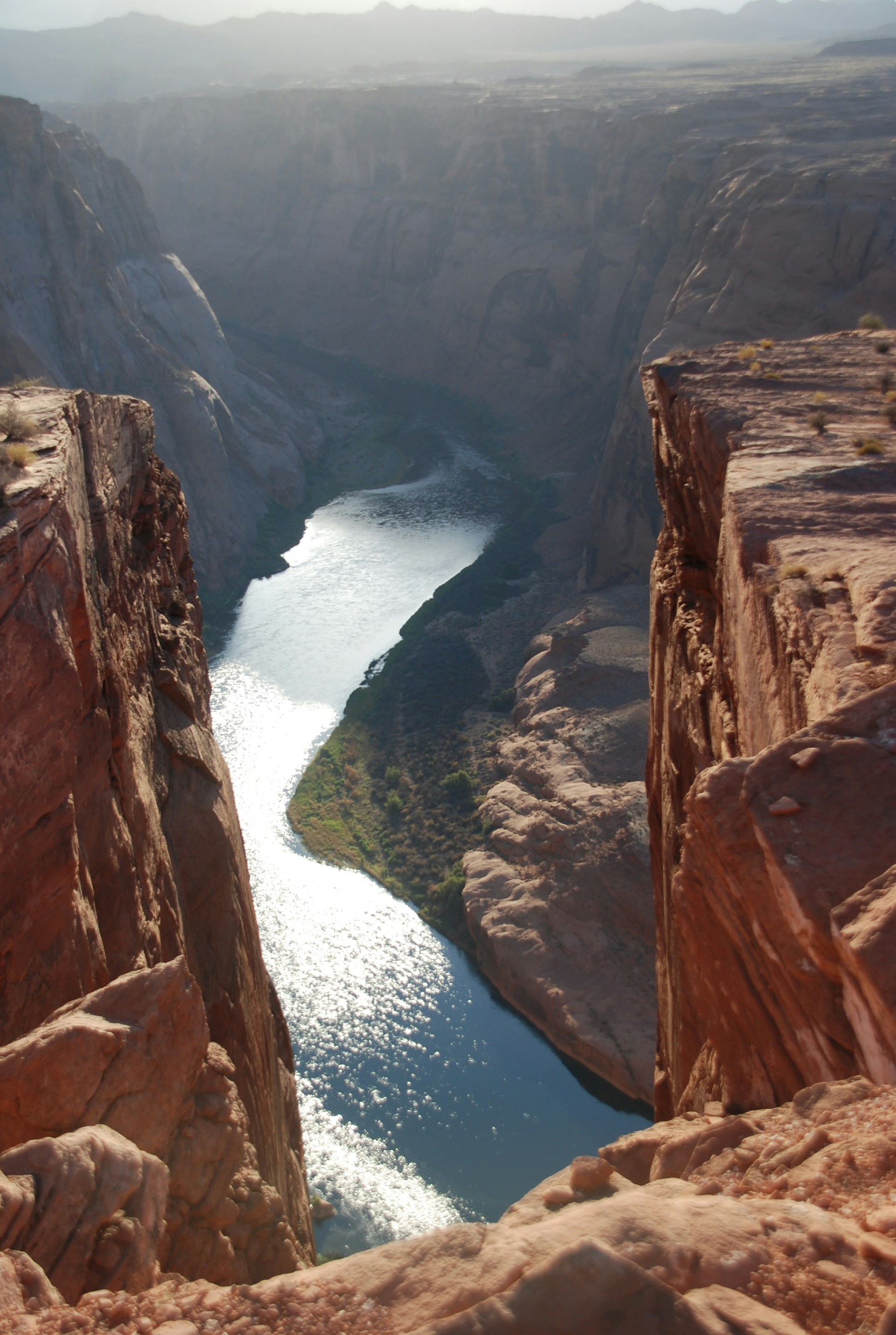 Gorge Deep: A River Carves Light Through Red Canyon Cliffs