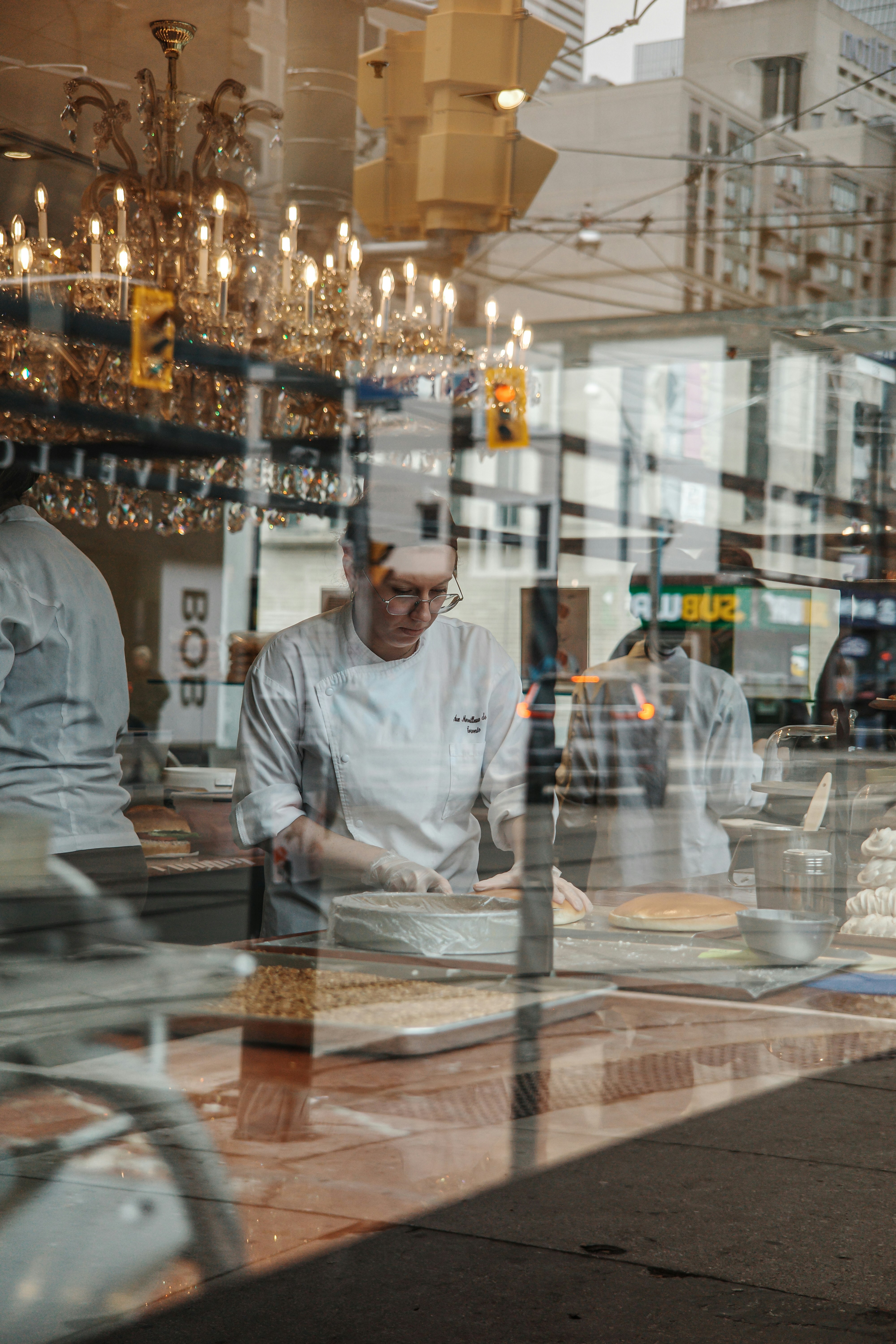 Chef at the Display Window: A Quiet Focus on Craft Behind Glass