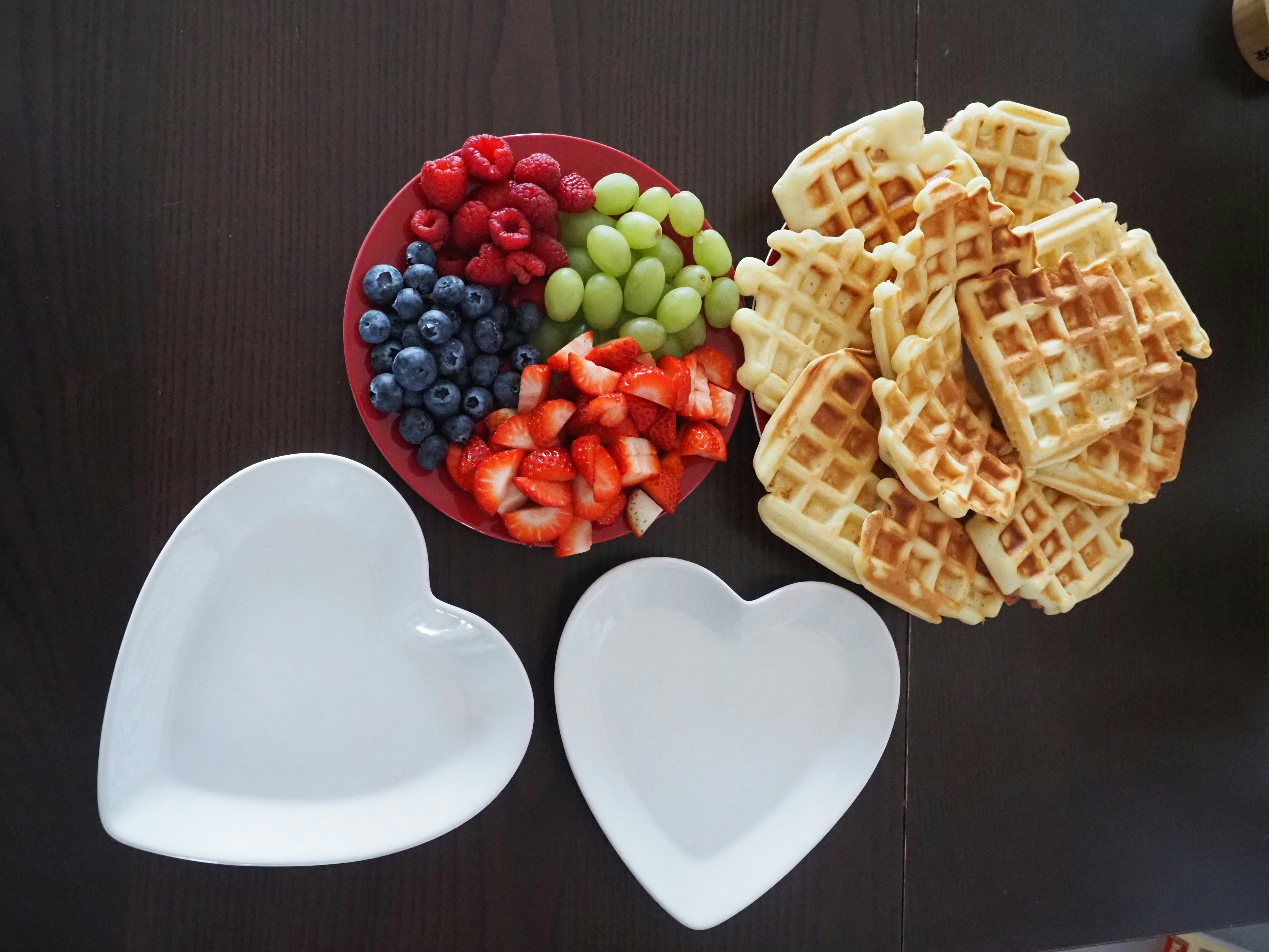 Fruit Buffet Ringed by Waffles on a Dark Table