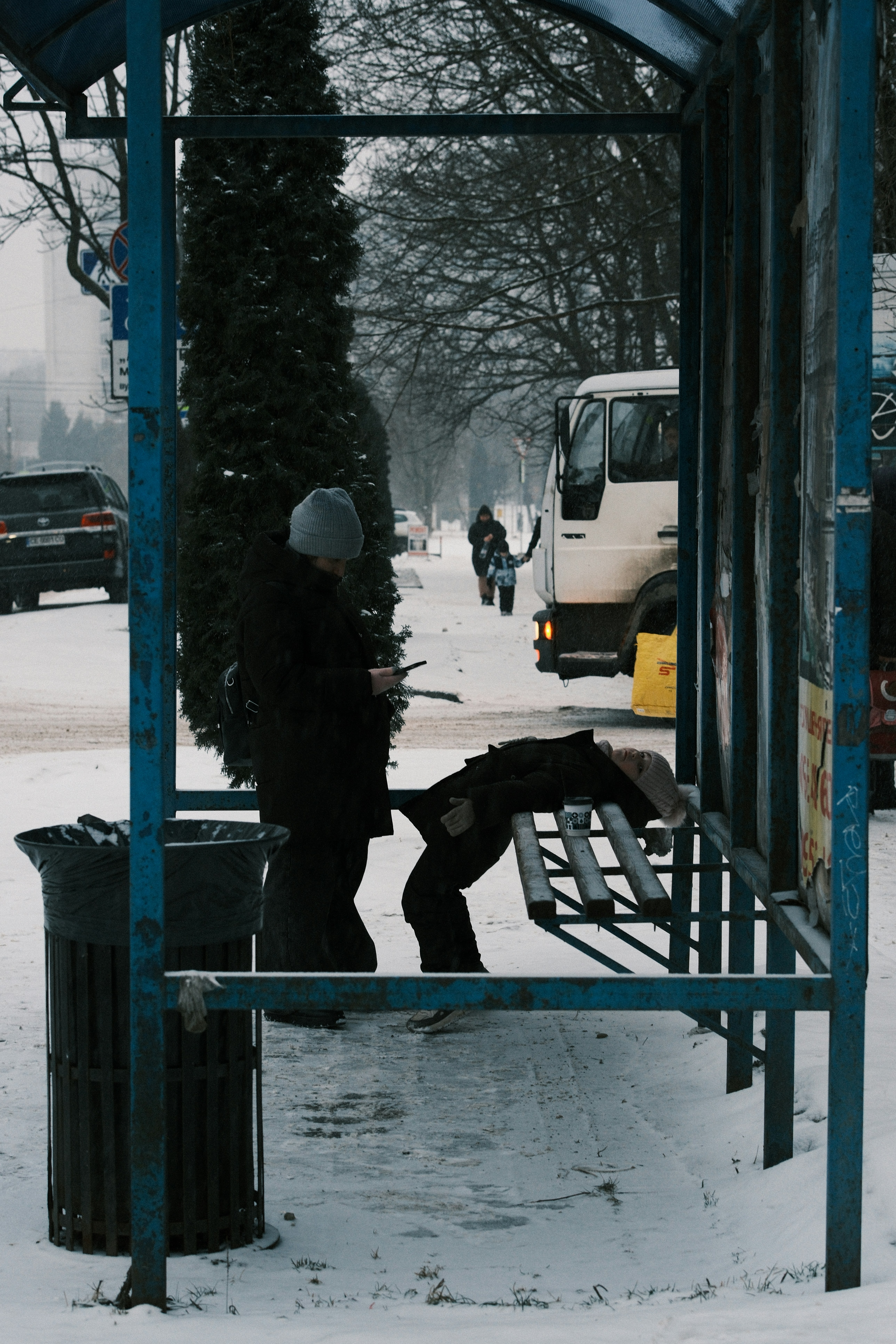Winter Bus Stop Ritual in Soft Snow