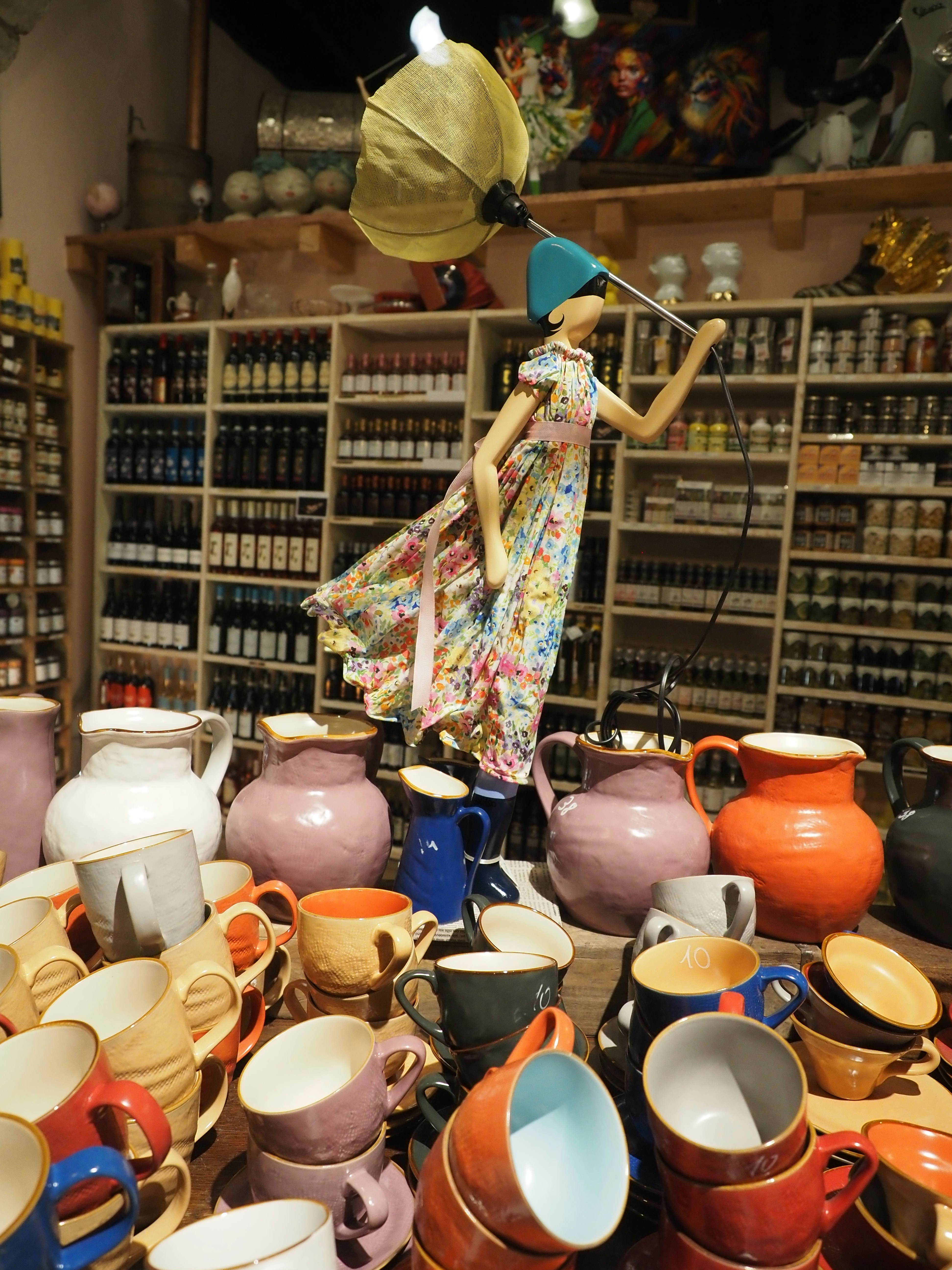Ceramic Jungle: A Marionette Silhouette Among Painted Mugs