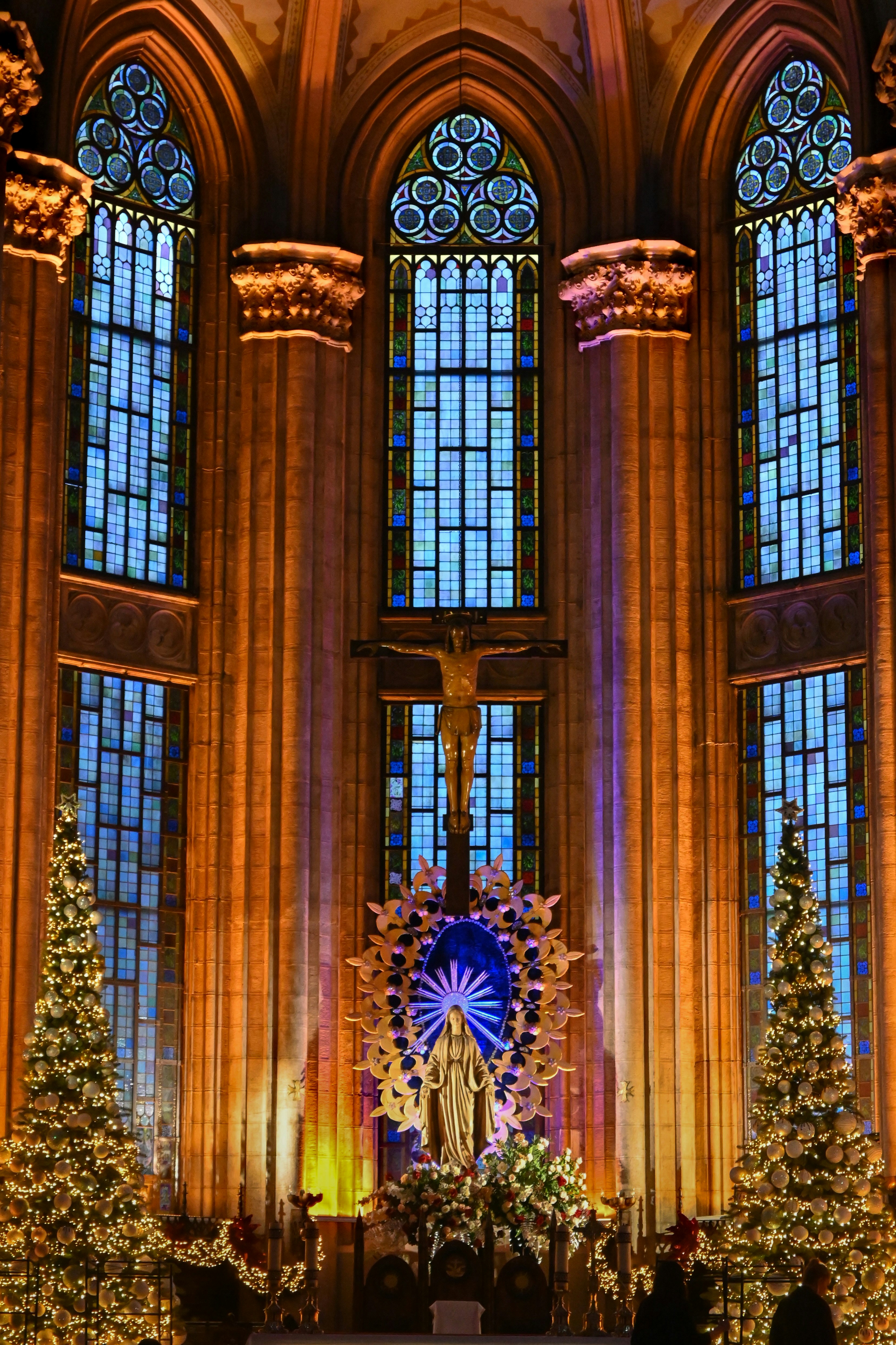 Cruciform Glory: A Nativity Shrine Framed by Stained Glass Fields