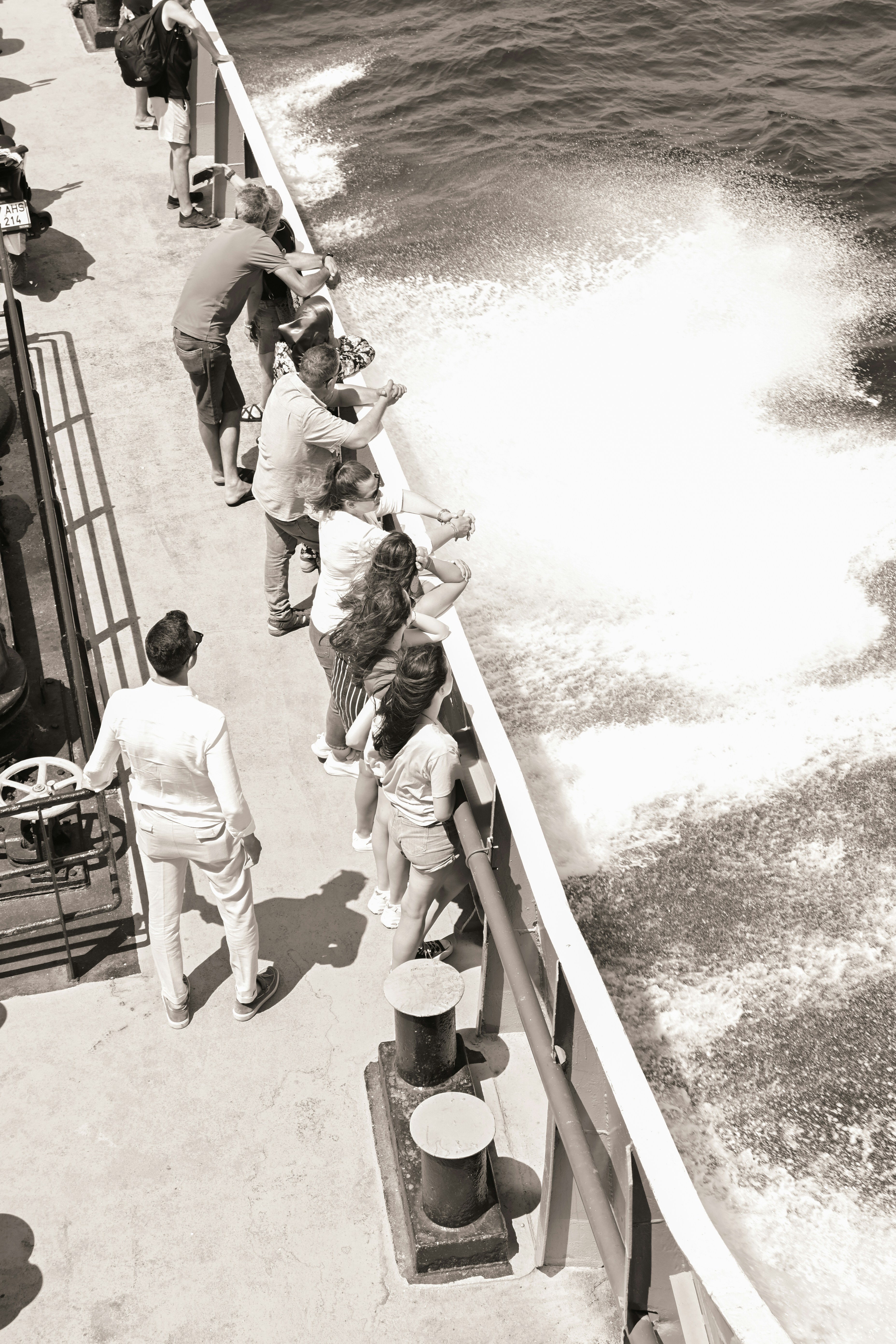 Across the Rail: Faces Peering Over the Waterline
