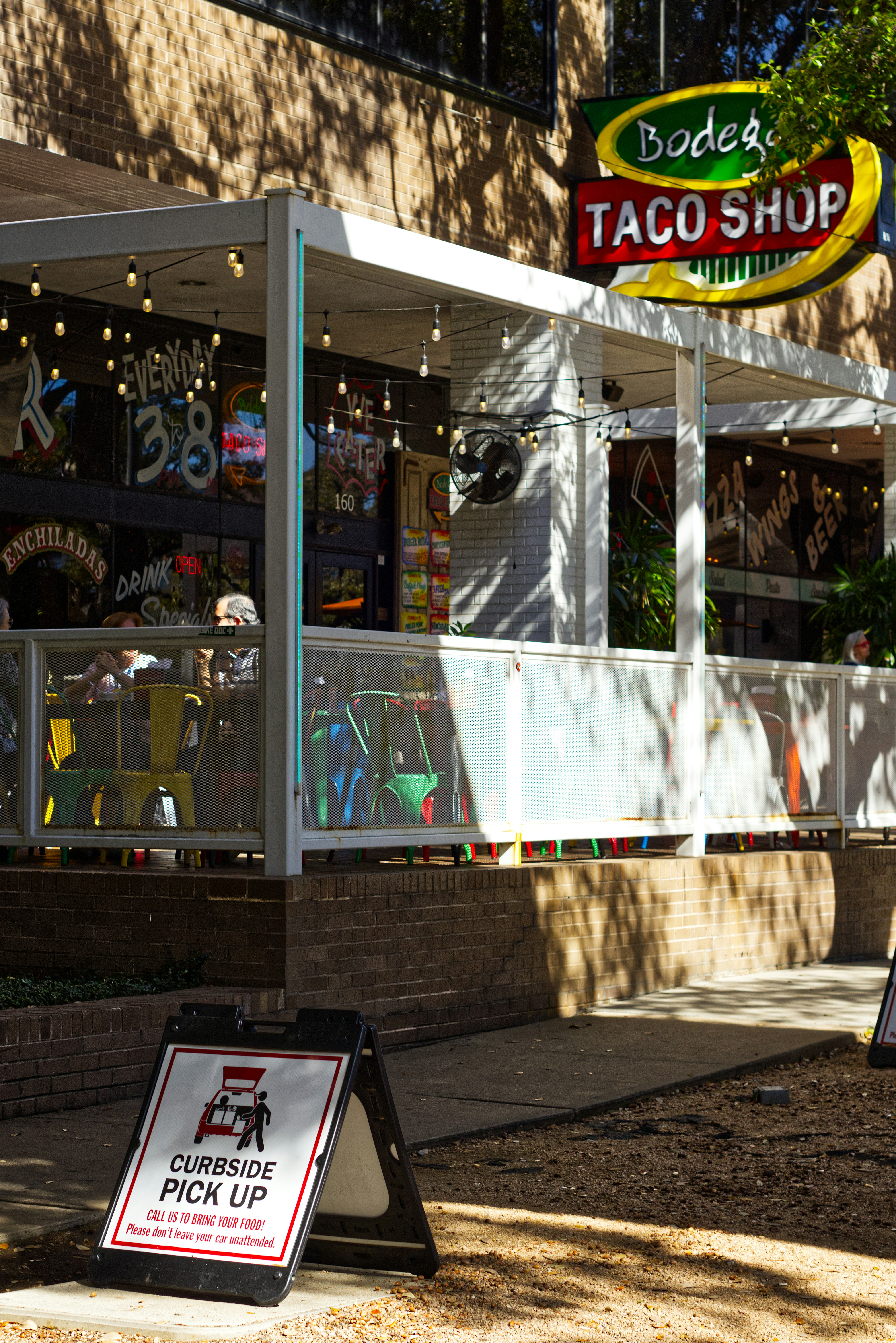  Taco Shop Terrace: Sunlit Scene Through Glass and Strings