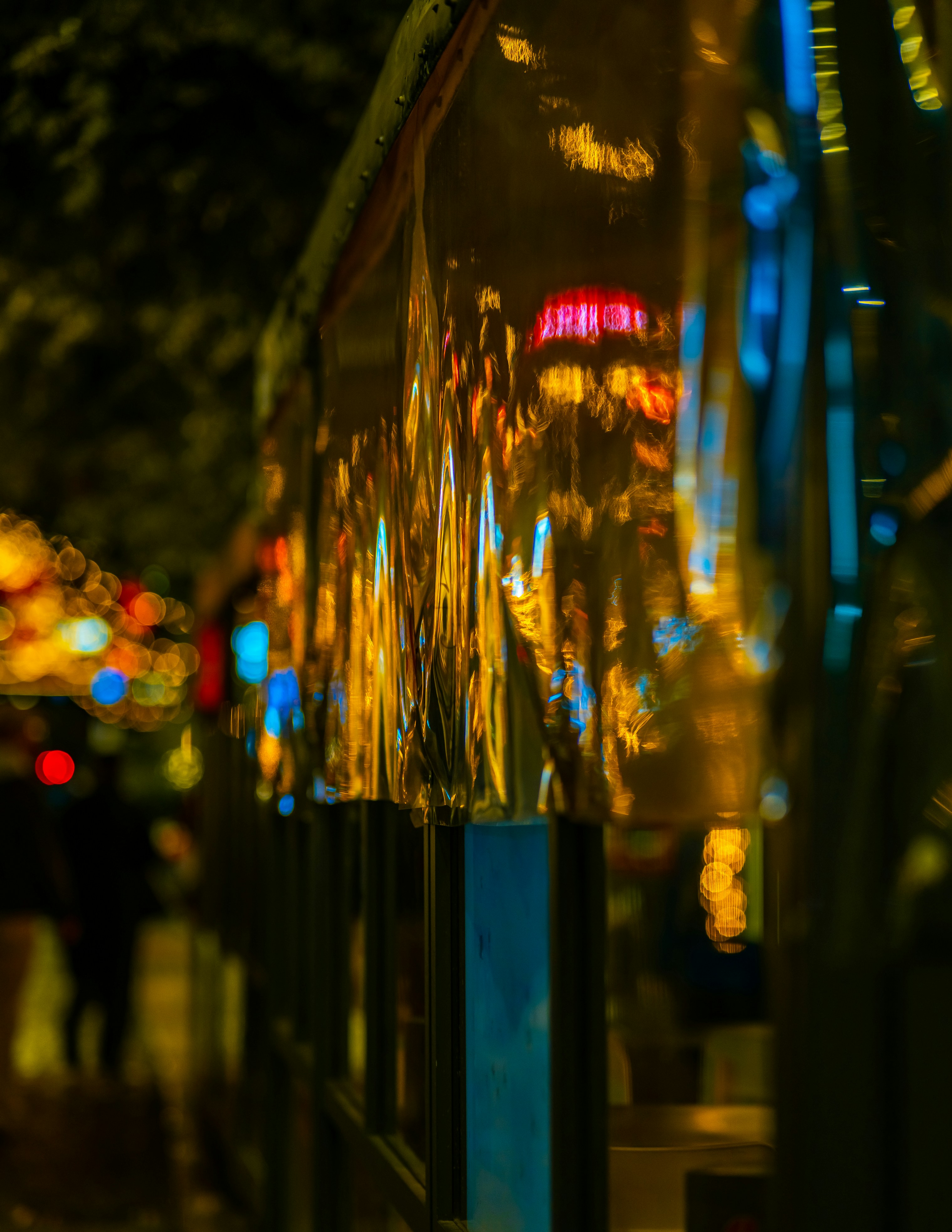 Neon Reflections on a Nighttime Transit Facade