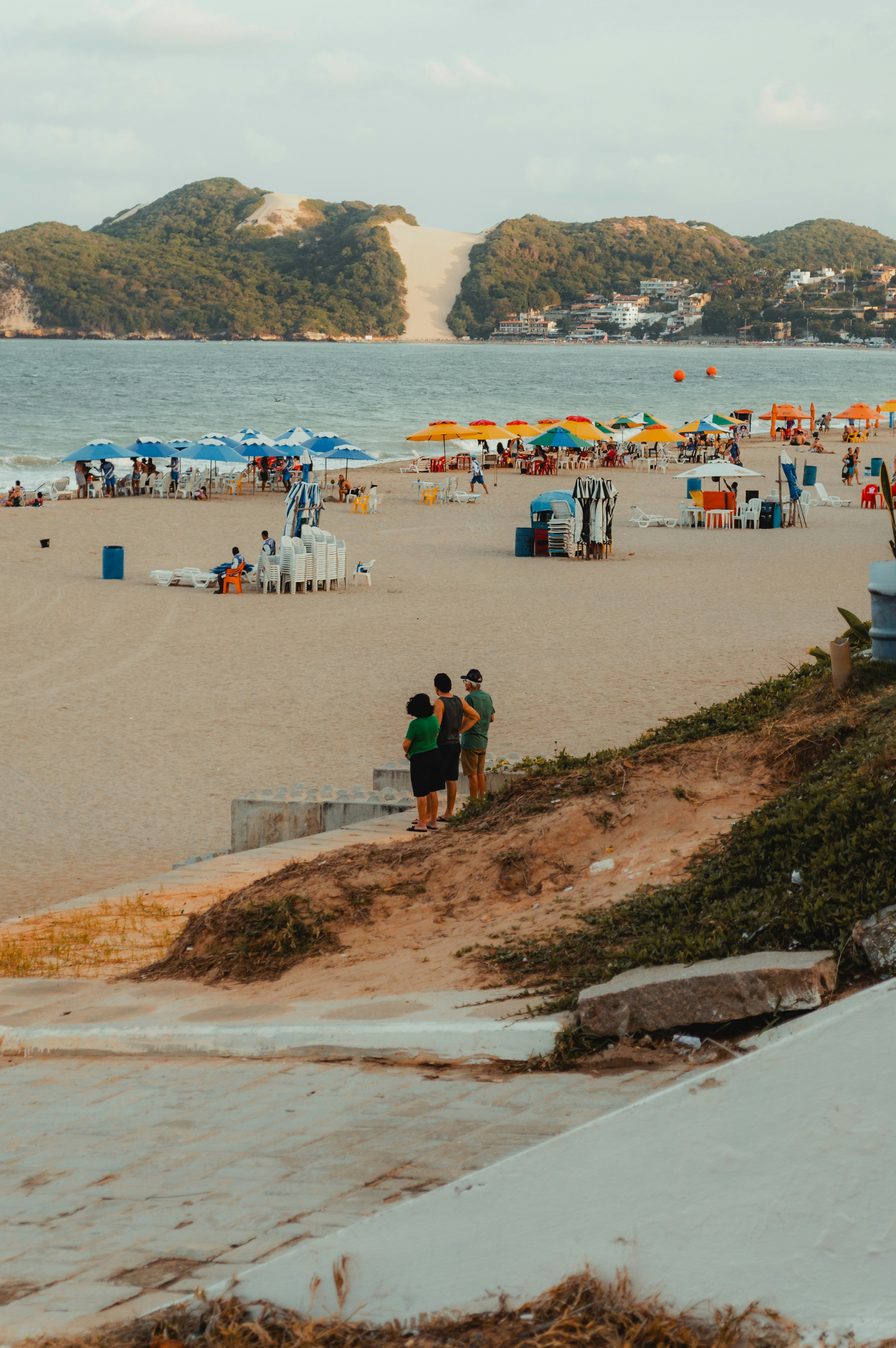 Lifeguard Shadows and Colorful Umbrellas on a Quiet Beach