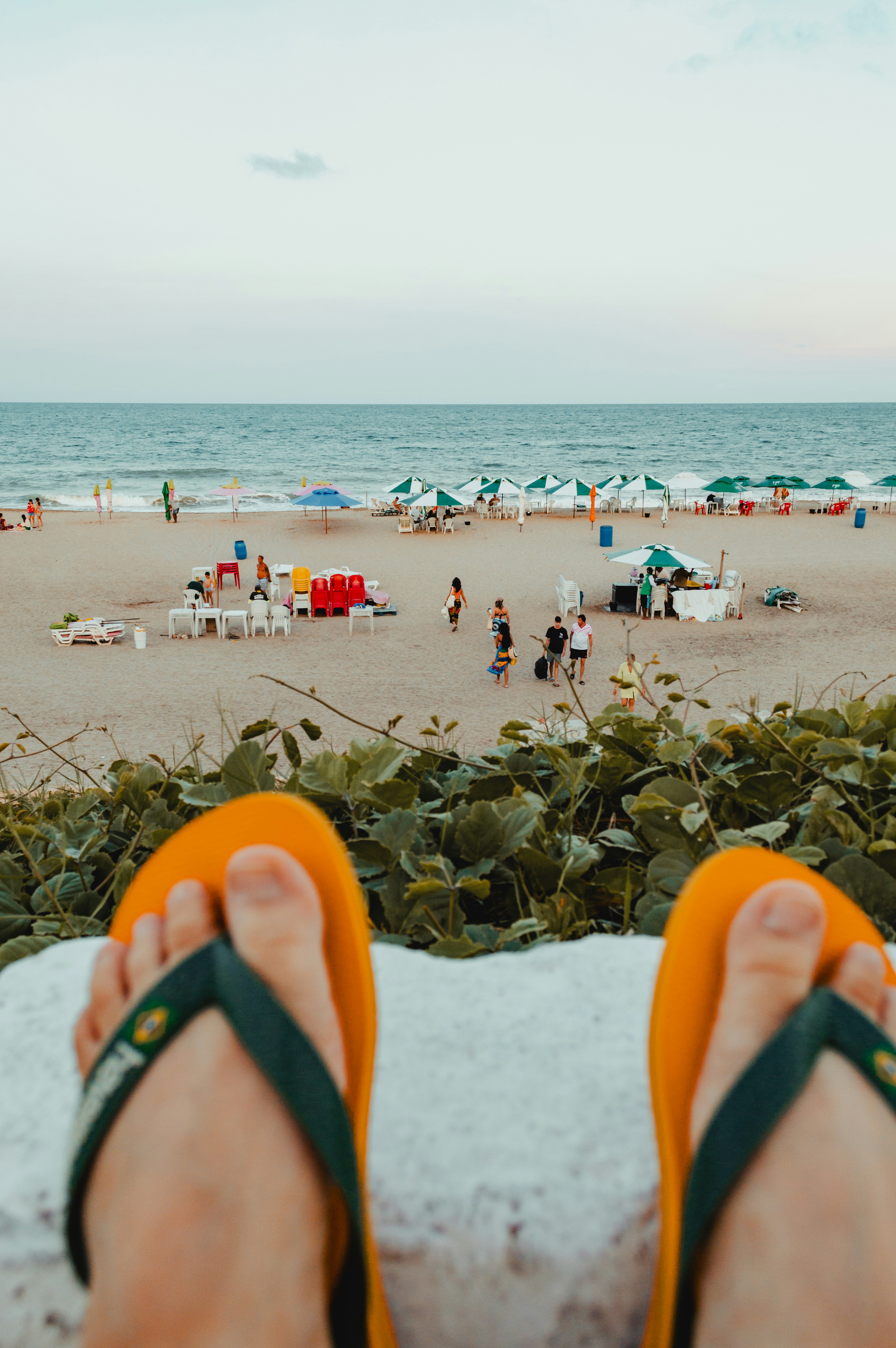 On the Edge: A First-Person Beach View from Sandal-Blue Flip-Flops