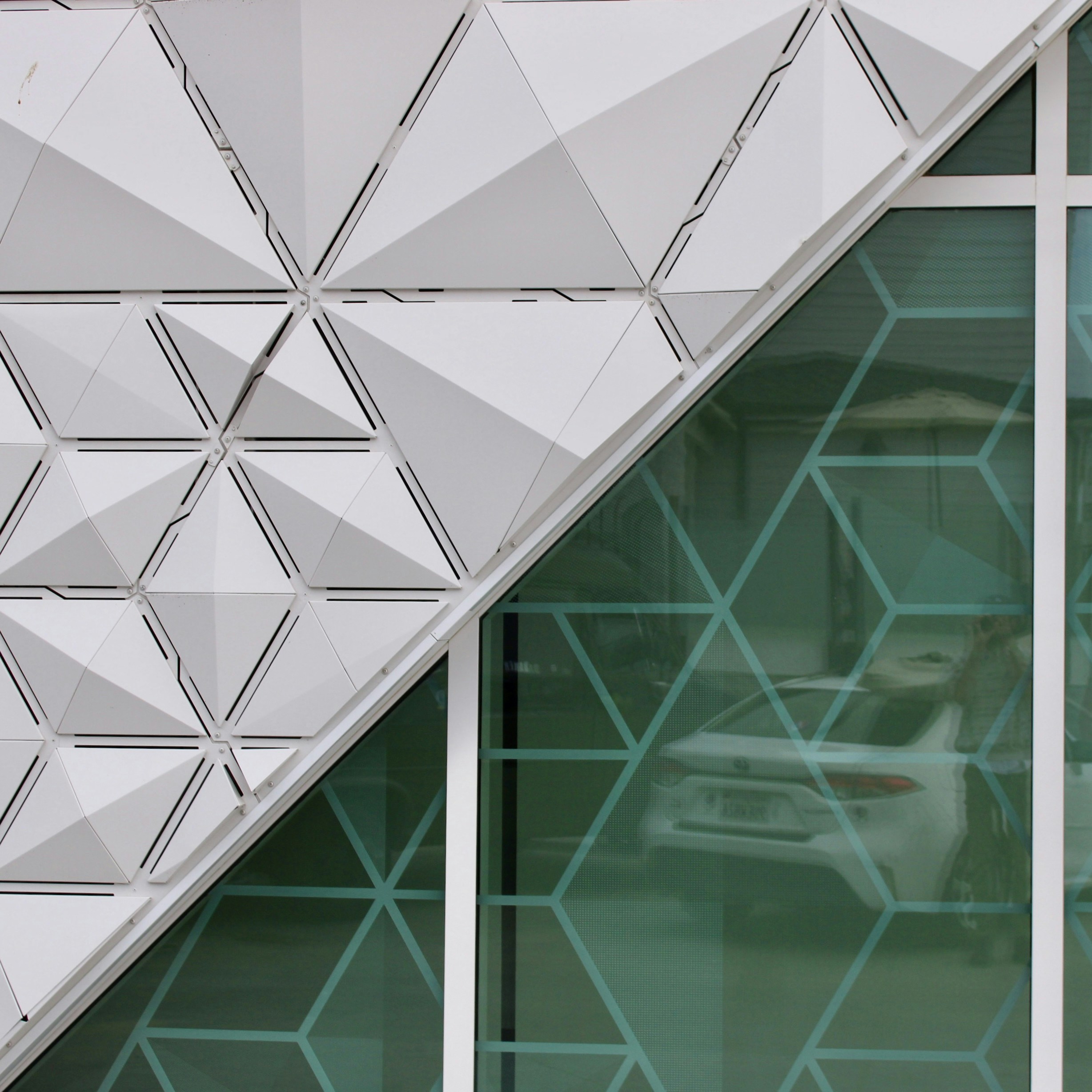 Faceted Facade: Geometric Light and Glass Across Angled Facade