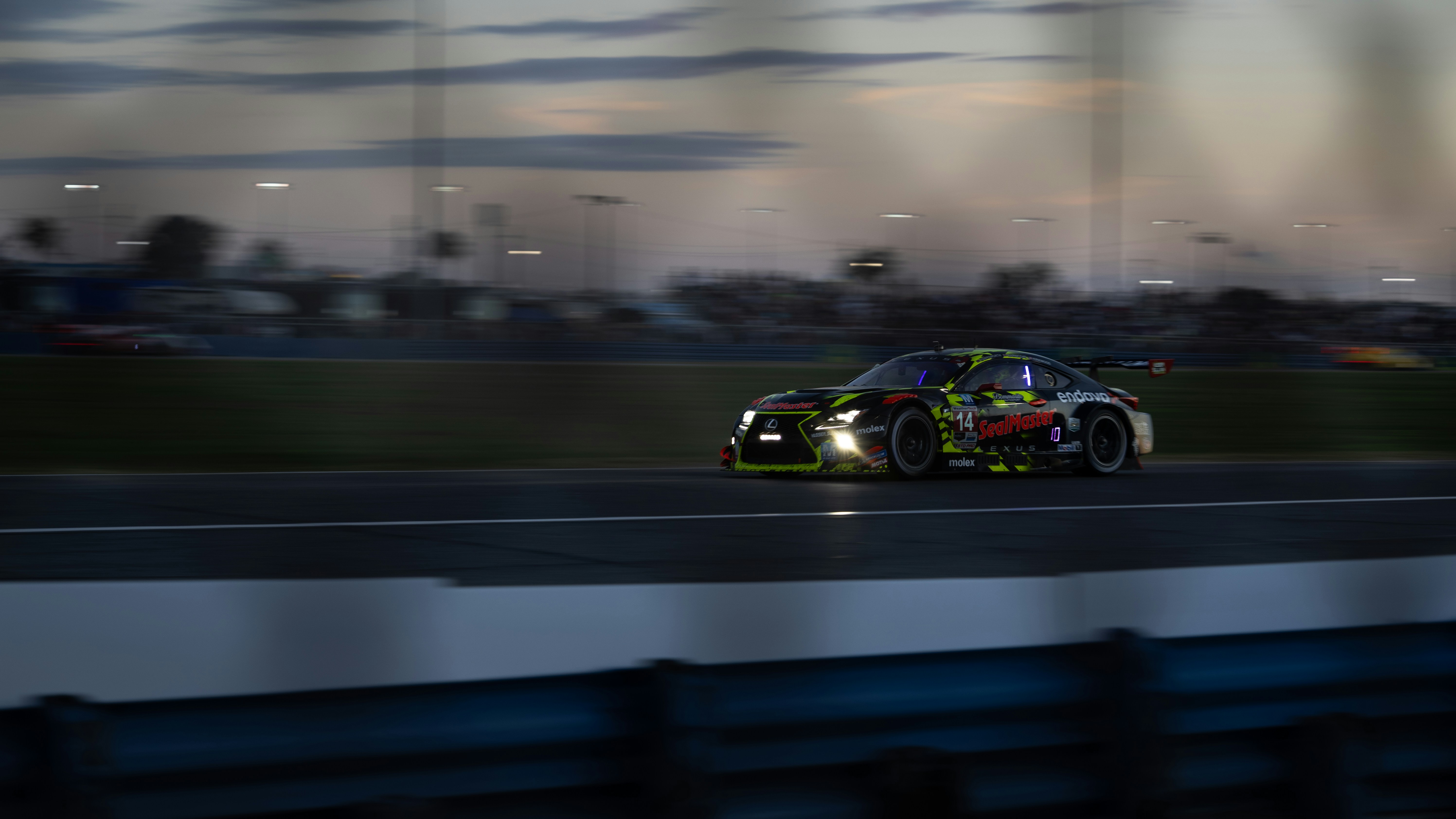 Pursuit at Dusk: Neon-Accent Race Car in Motion