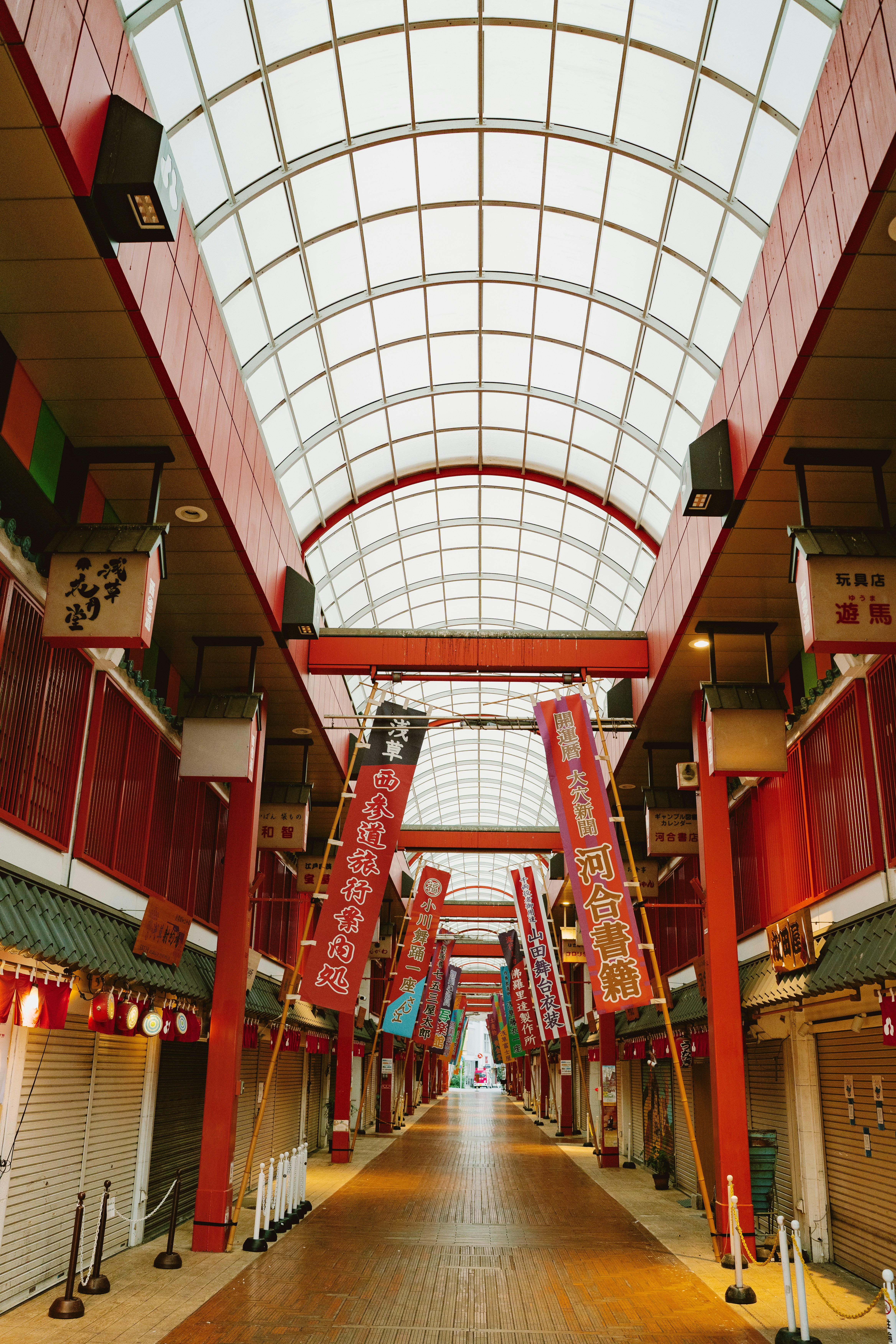 Red Lantern Corridor: A Quiet Street Through a Sunlit Market Arcade