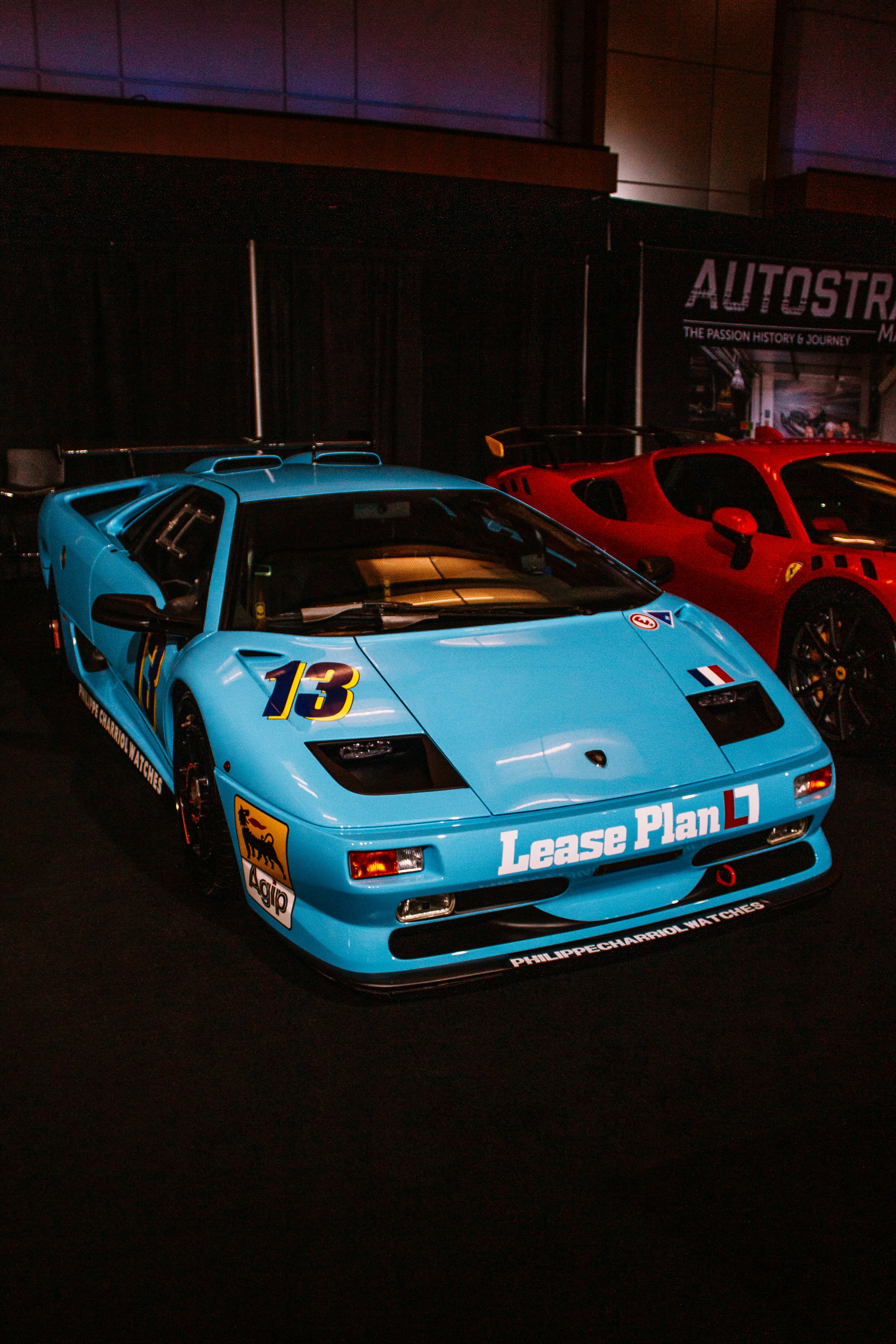 Blue Lamborghini Countach-style race car on display at an indoor show