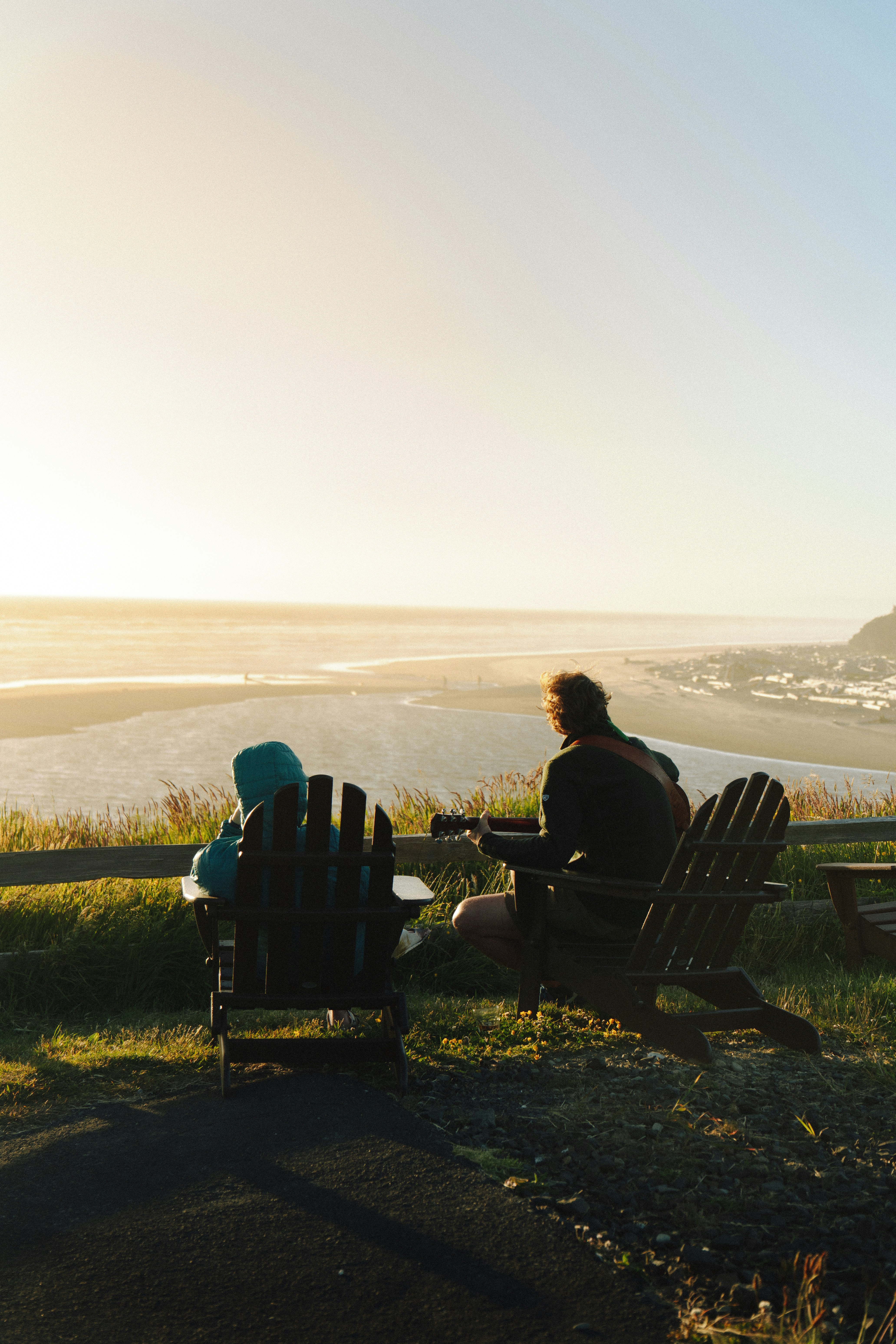 Sunlit Quiet: A Guitar Player and Companion by the Seaside